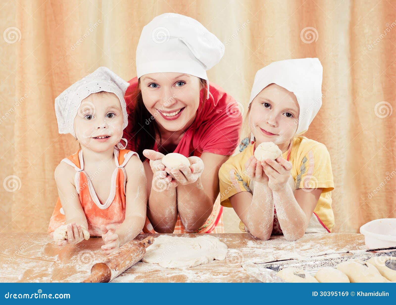 Mother with Two Daughters Baking Bread. Stock Image - Image of ...