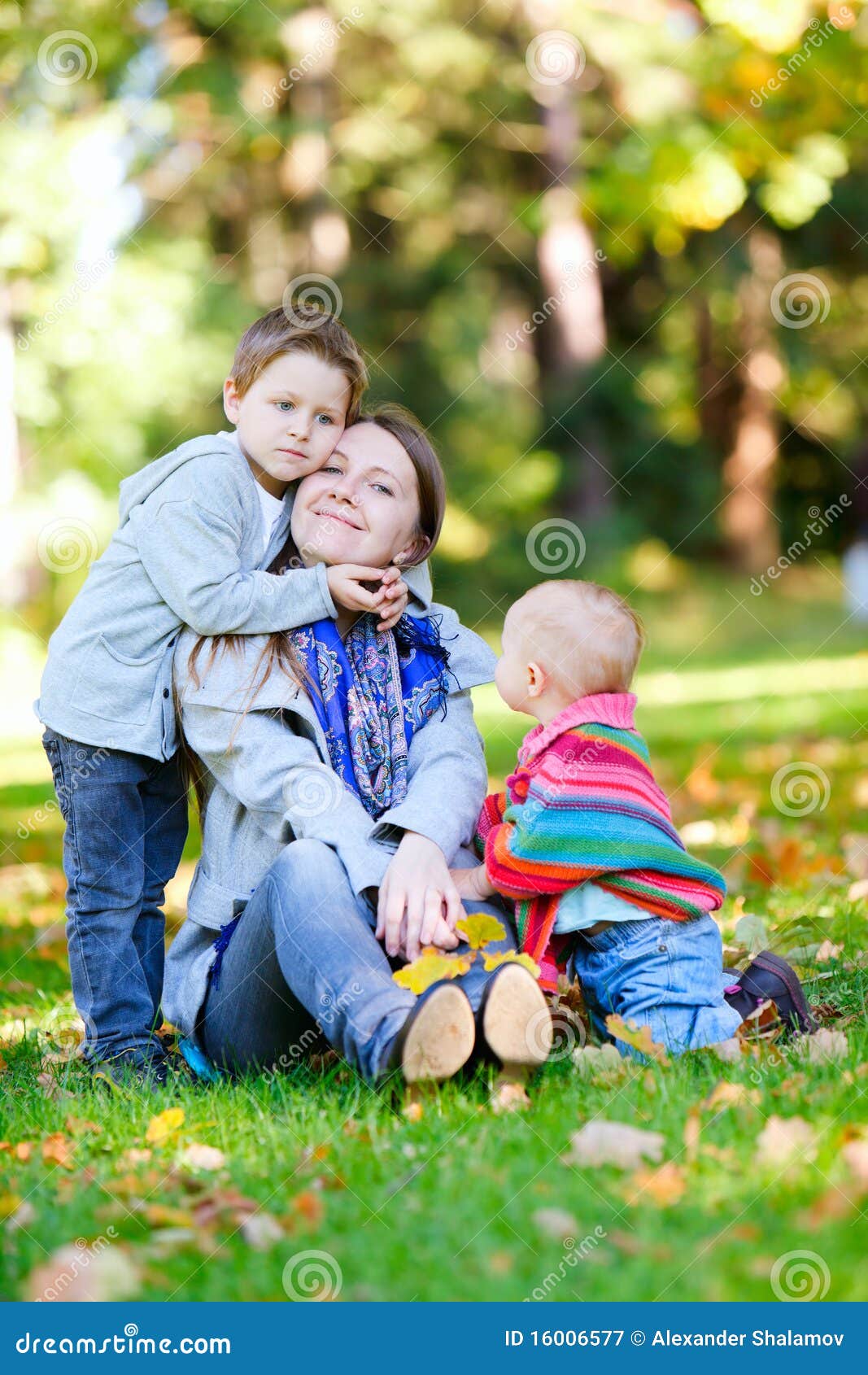 Mother and Two Kids Sitting on Grass Stock Image - Image of autumn ...