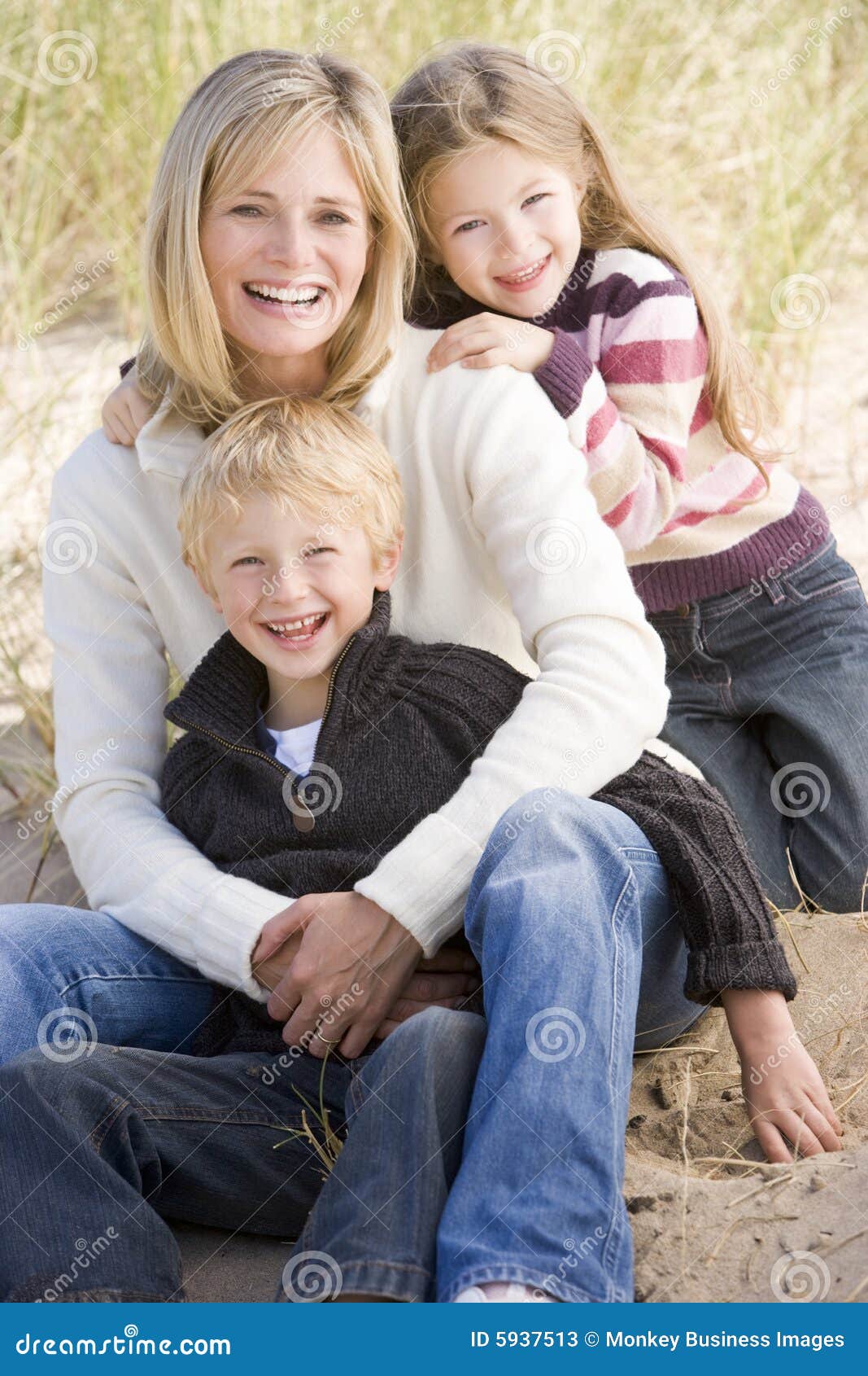 Mother and Two Young Children Sitting on Beach Stock Image - Image of ...
