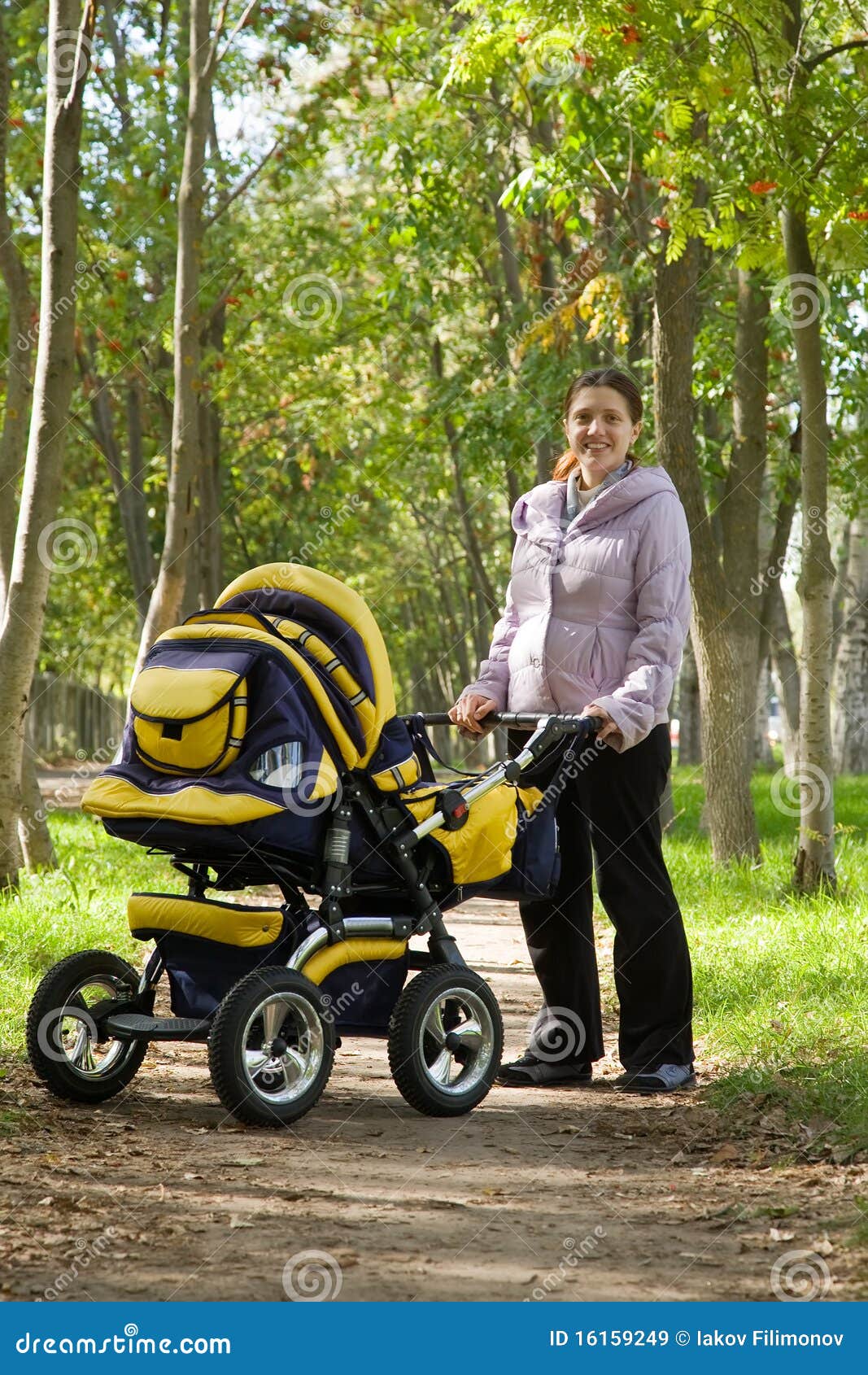 Mother walking with pram stock image. Image of autumn - 16159249
