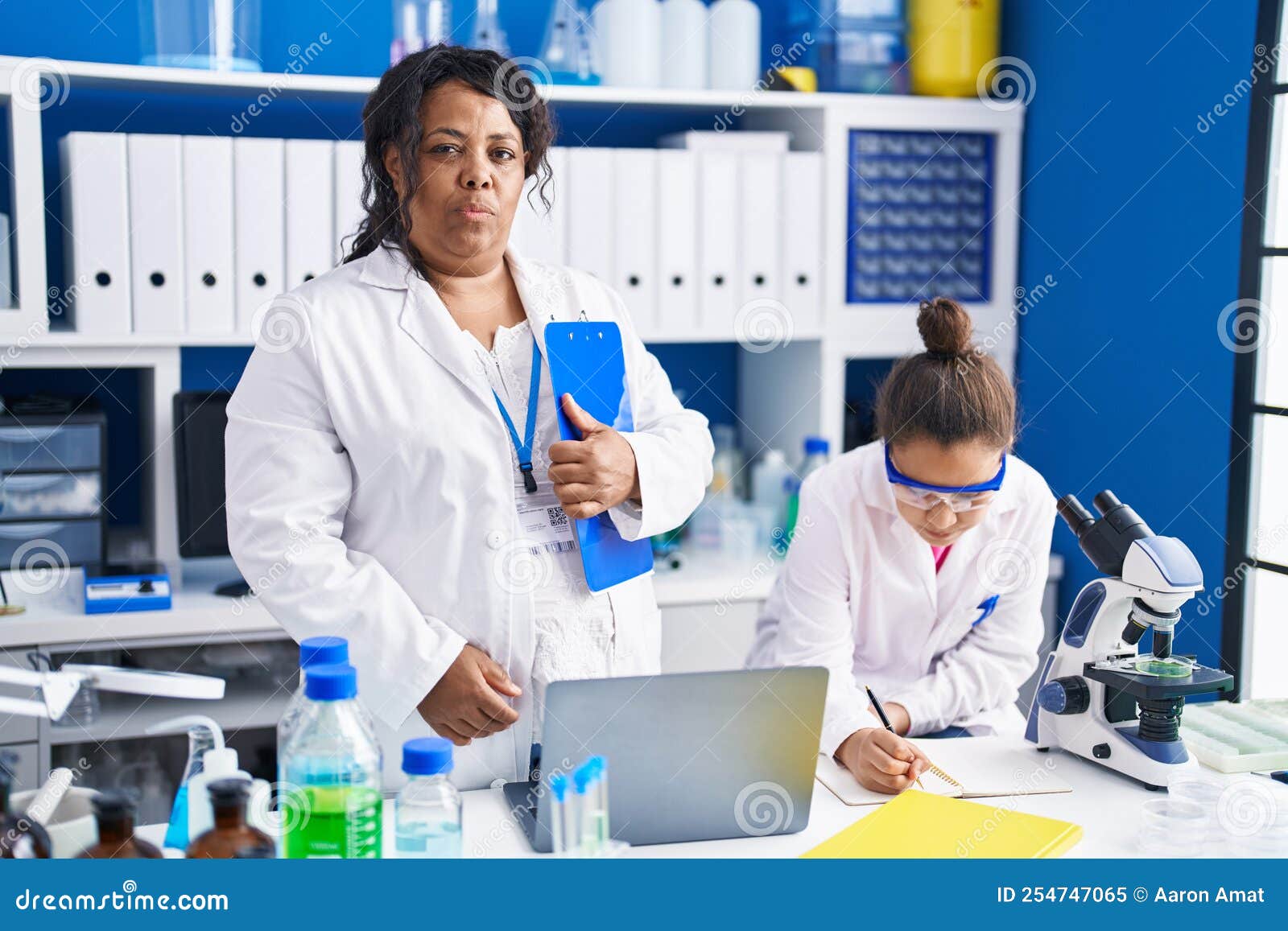 Mother and Young Daughter Working at Scientist Laboratory Thinking ...