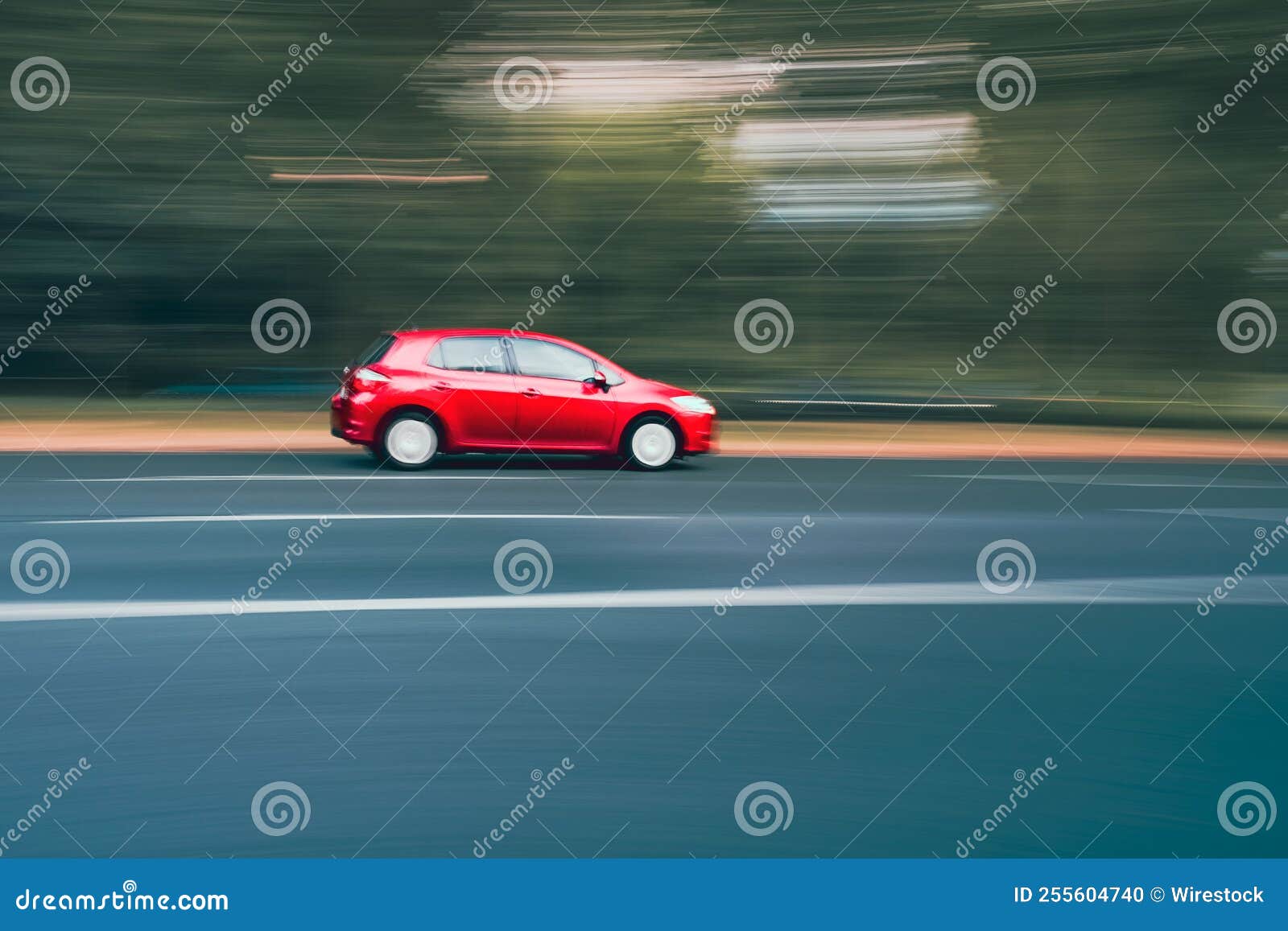 Motion Blur Shot of a Red Car Driving Fast in a Road Stock Photo ...