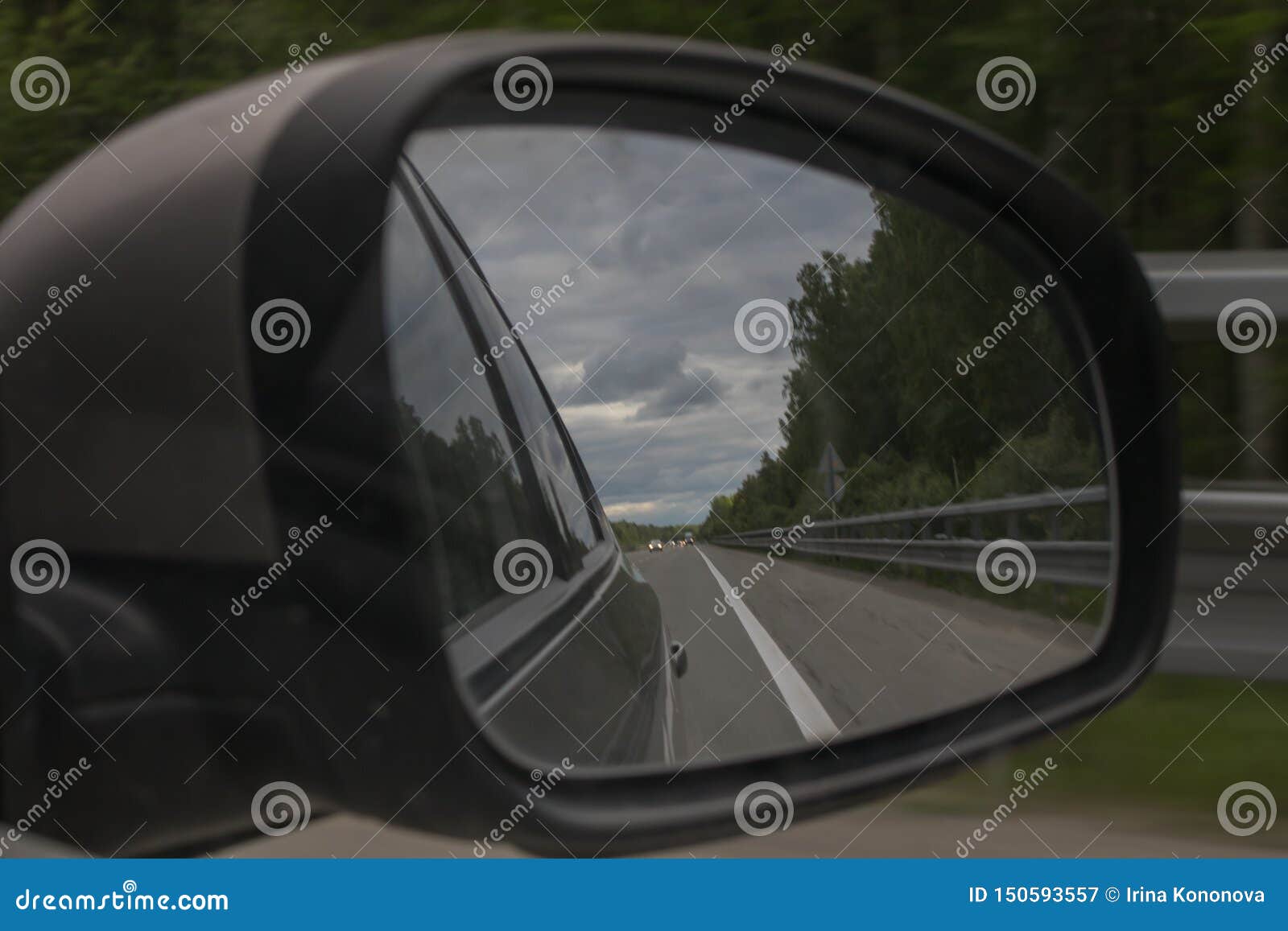 Motion Blur. View of the Forest Road through the Side Mirror of the Car ...