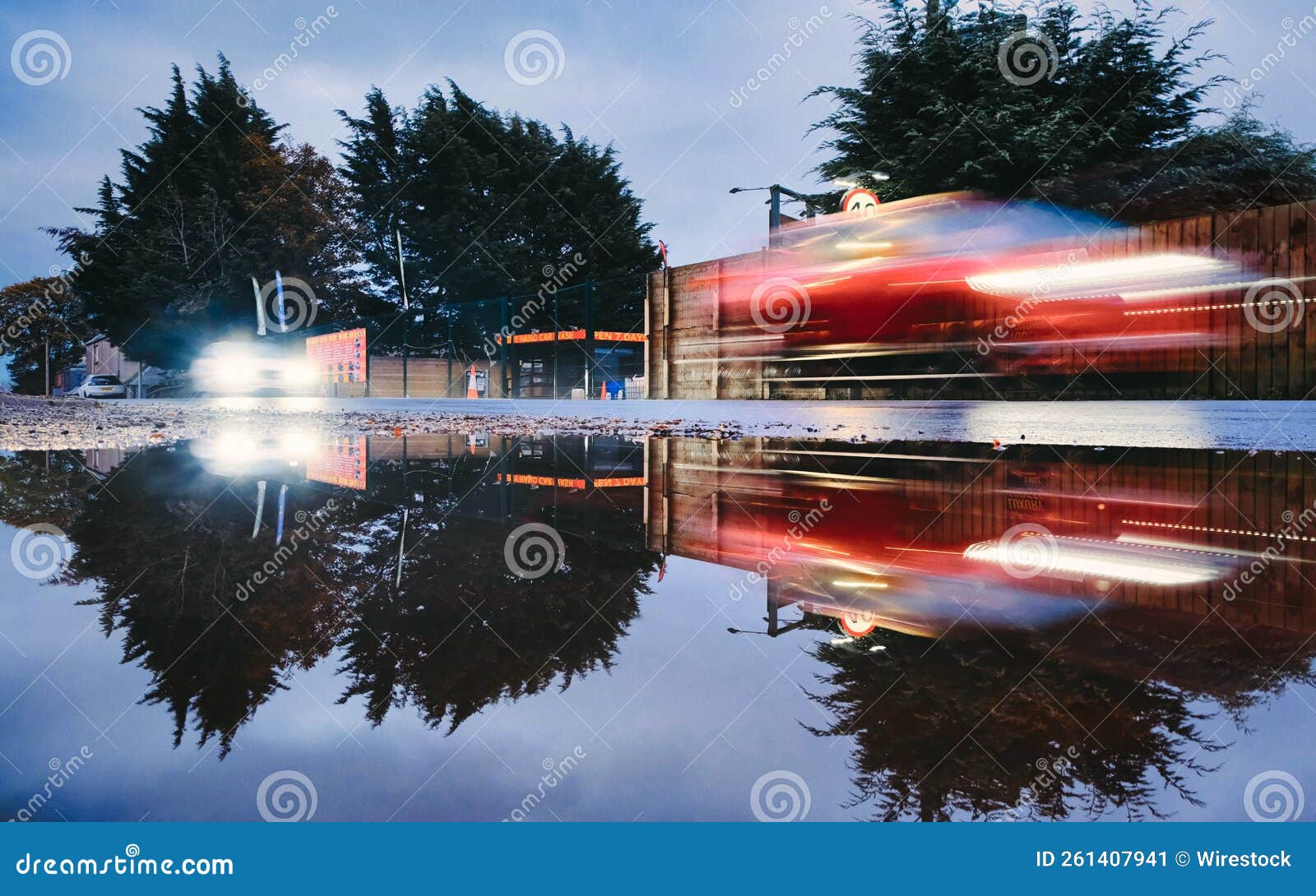 Blurred Car Reflection in Puddle Stock Image - Image of blue, headlights: 261407941