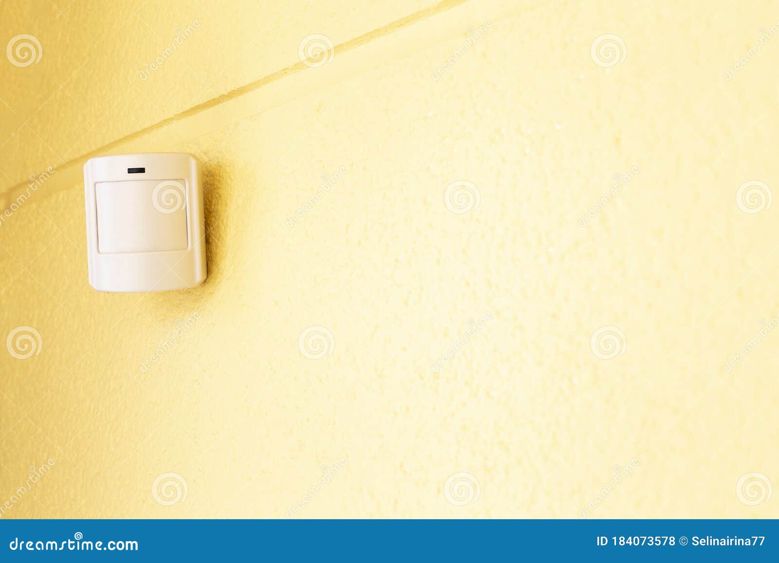 Motion Sensor or Detector for Security System on a Yellow Wall Indoors ...