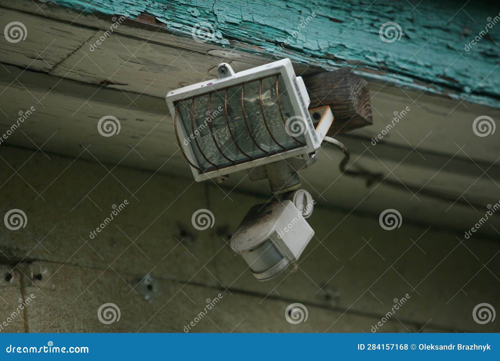 Motion Sensor and LED Spotlight on the Wall of the Building. Automatic ...