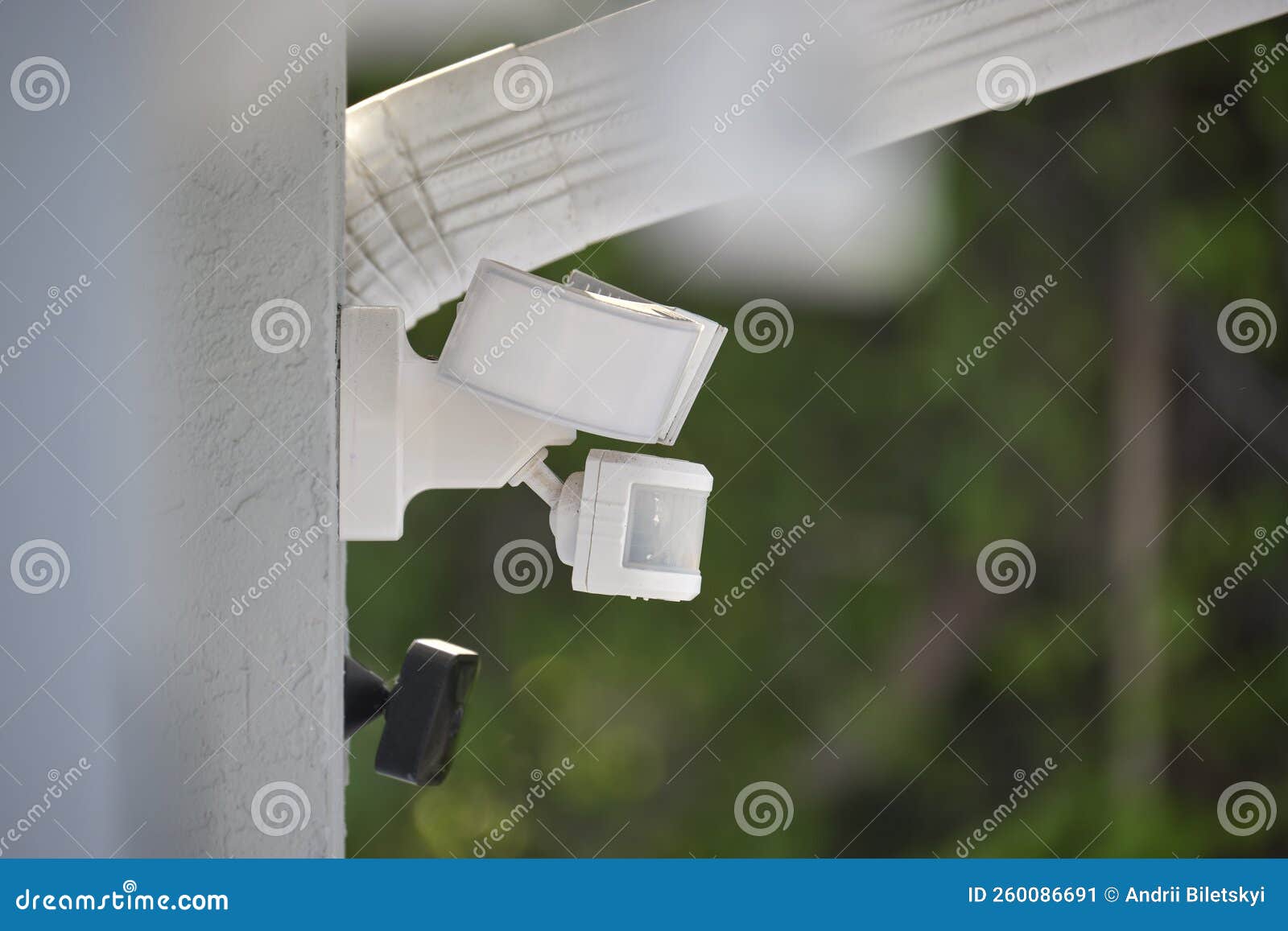 Motion Sensor with Light Detector Mounted on Exterior Wall of Private ...