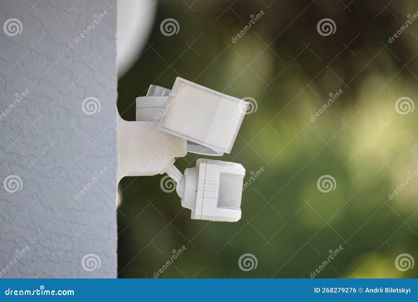 Motion Sensor with Light Detector Mounted on Exterior Wall of Private ...