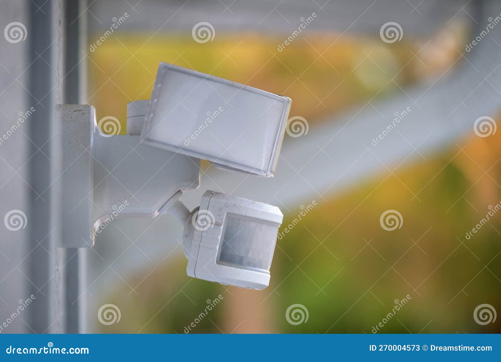 Motion Sensor with Light Detector Mounted on Exterior Wall of Private ...