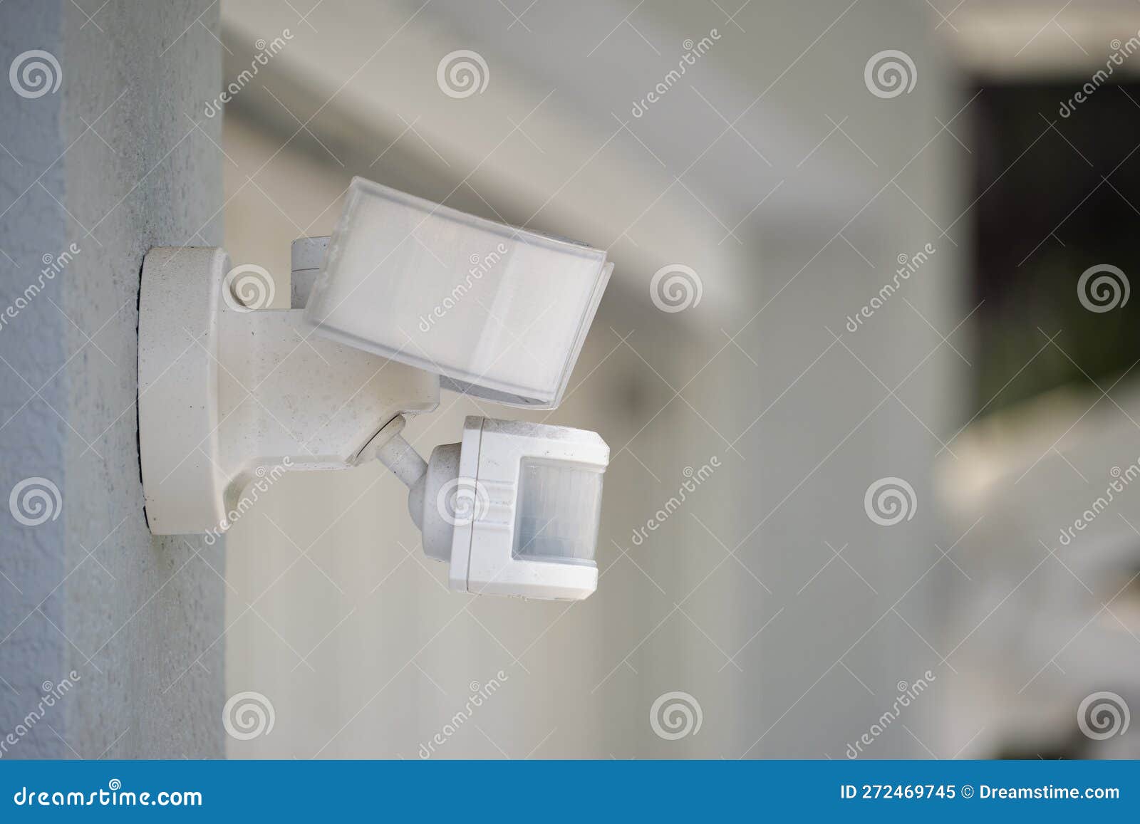 Motion Sensor with Light Detector Mounted on Exterior Wall of Private ...