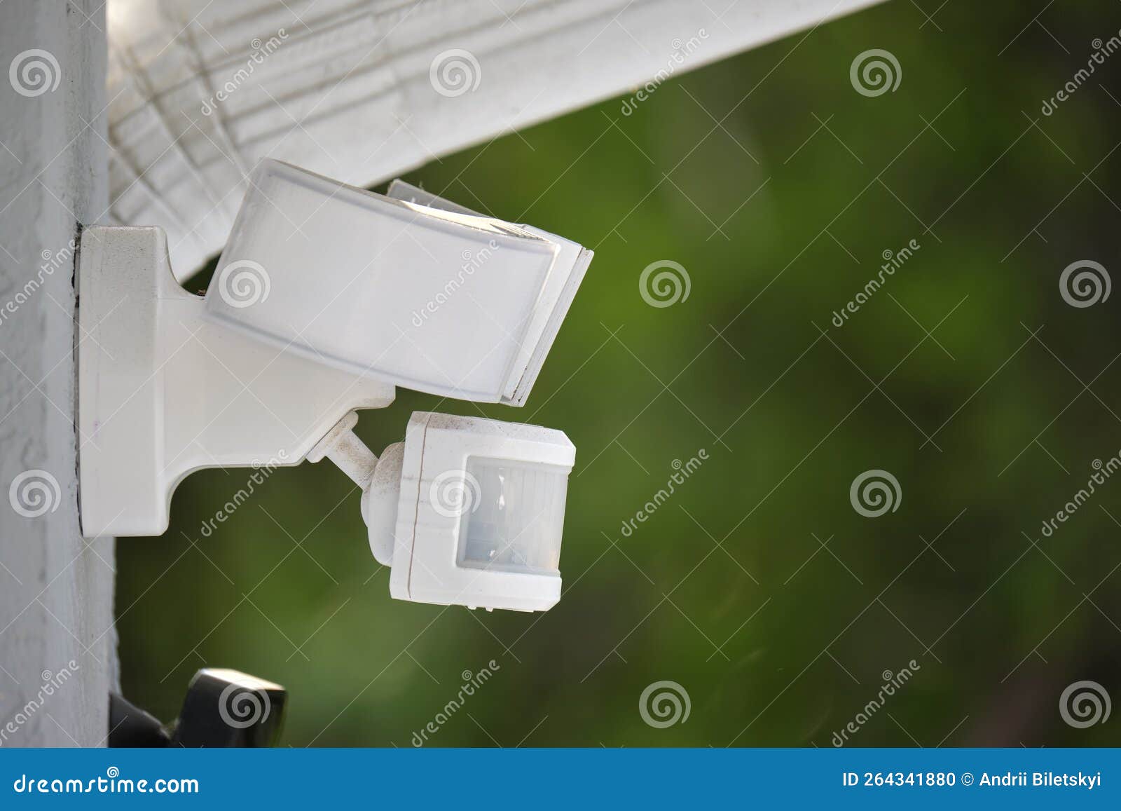 Motion Sensor with Light Detector Mounted on Exterior Wall of Private ...