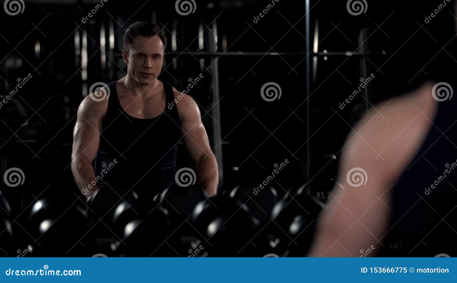 Motivated Bodybuilder Looking in Mirror Reflection during Break between ...
