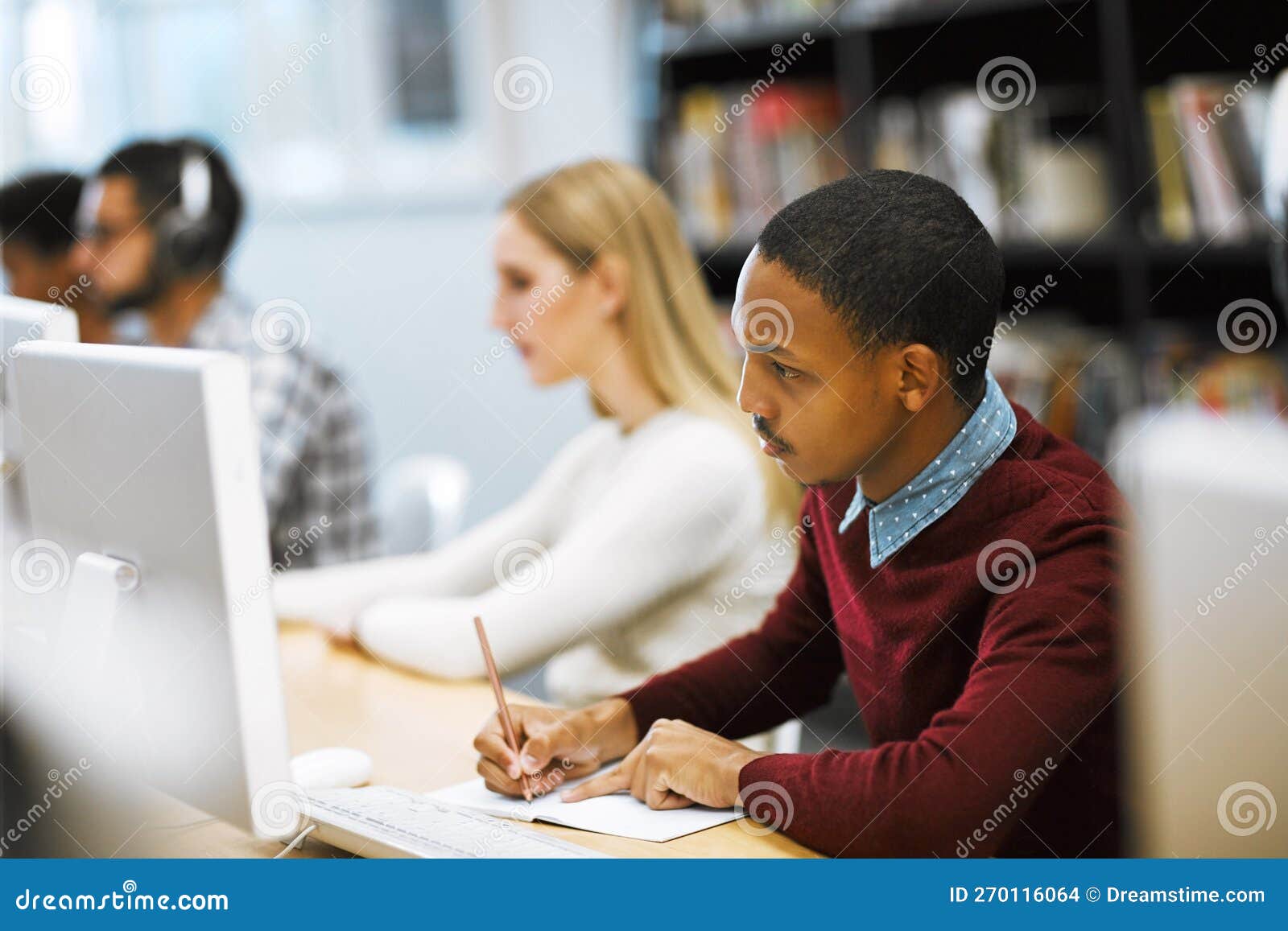 Motivated To Get this Done. a Group Young Students Working on Computers ...