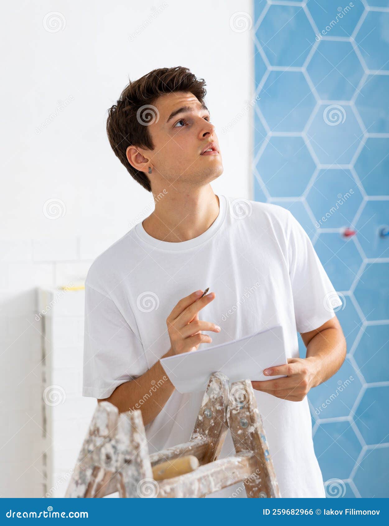 Motivated Guy Taking Notes while Working on Renovation of House Stock ...