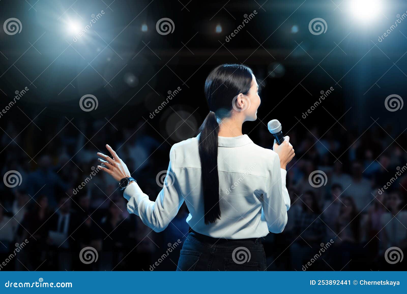 Motivational Speaker with Microphone Performing on Stage, Back View ...