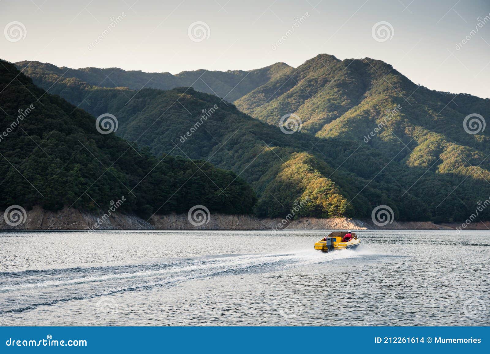 Motor Boat Sailing on Lake with Mountain Range in Dam Stock Photo ...
