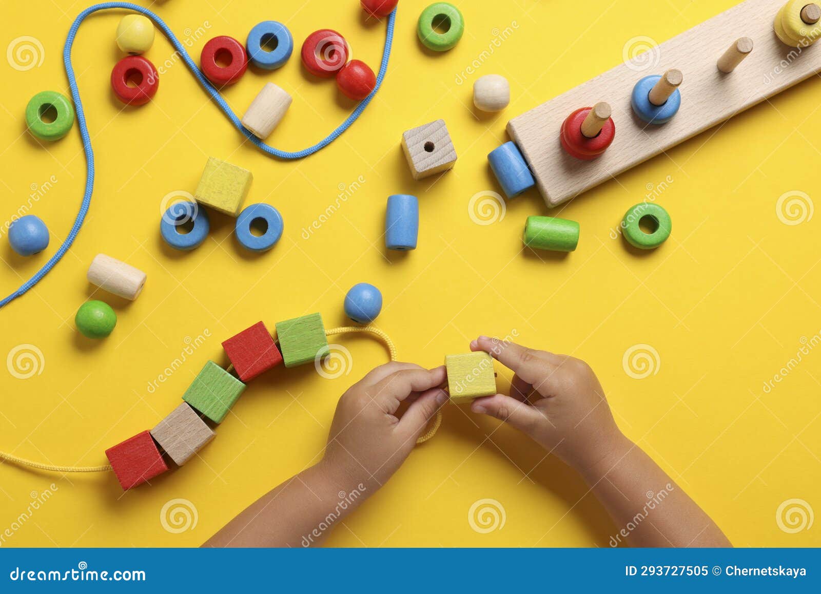 Motor Skills Development. Little Child Playing with Wooden Pieces and ...