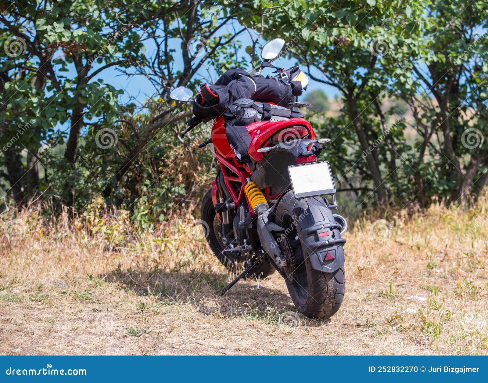 Motorcycle on the Field Near the Trees Stock Photo - Image of people ...