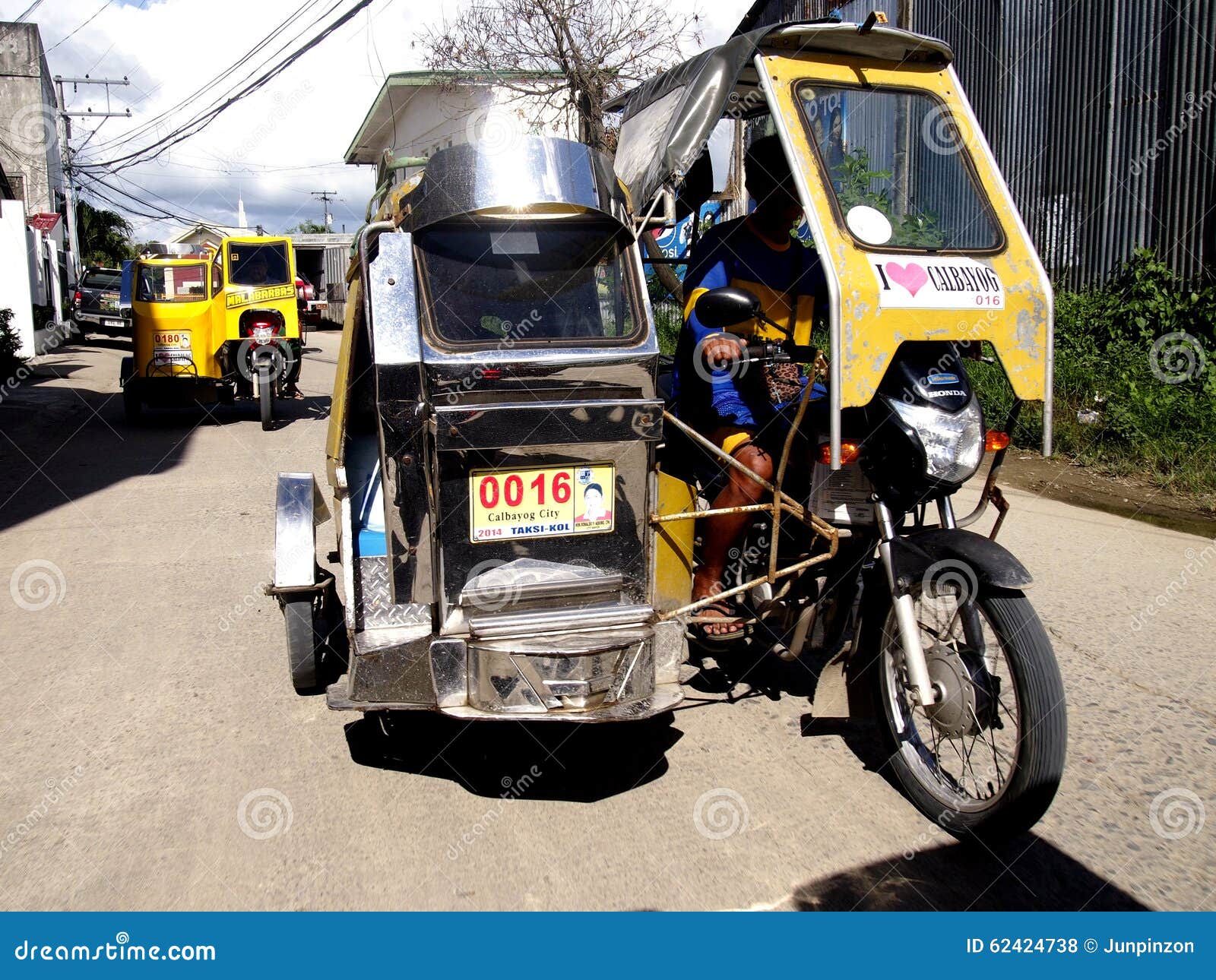 A Motorcycle Fitted with Additional Wheels and a Cab is Turned into ...