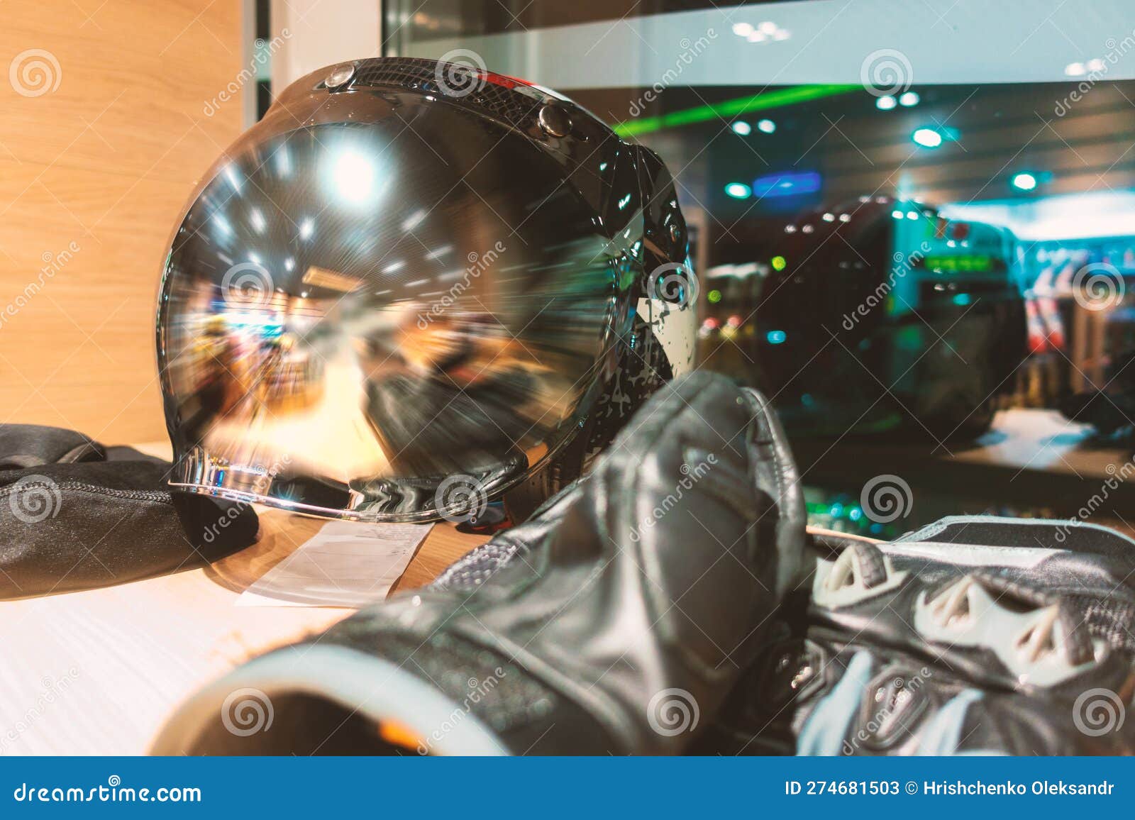 Motorcycle Helmet with Mirrored Visor and Leather Gloves on the Table ...
