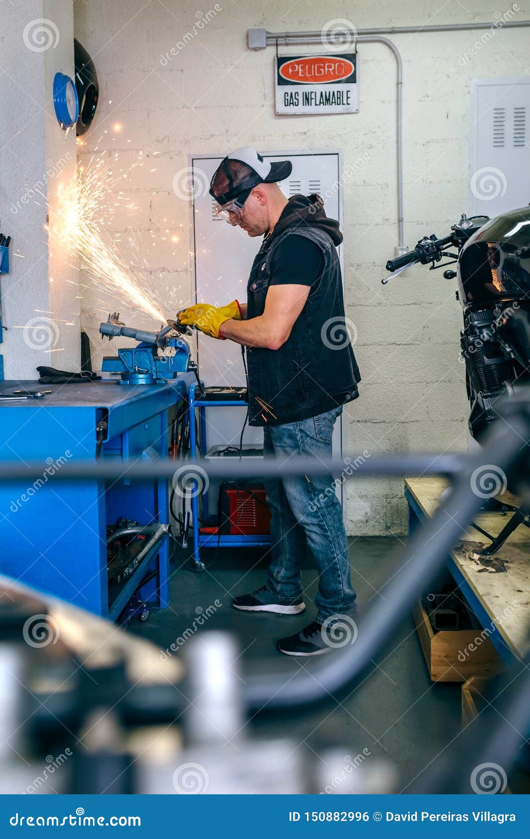 Motorcycle Mechanic Using a Grinder Stock Photo - Image of jeans ...