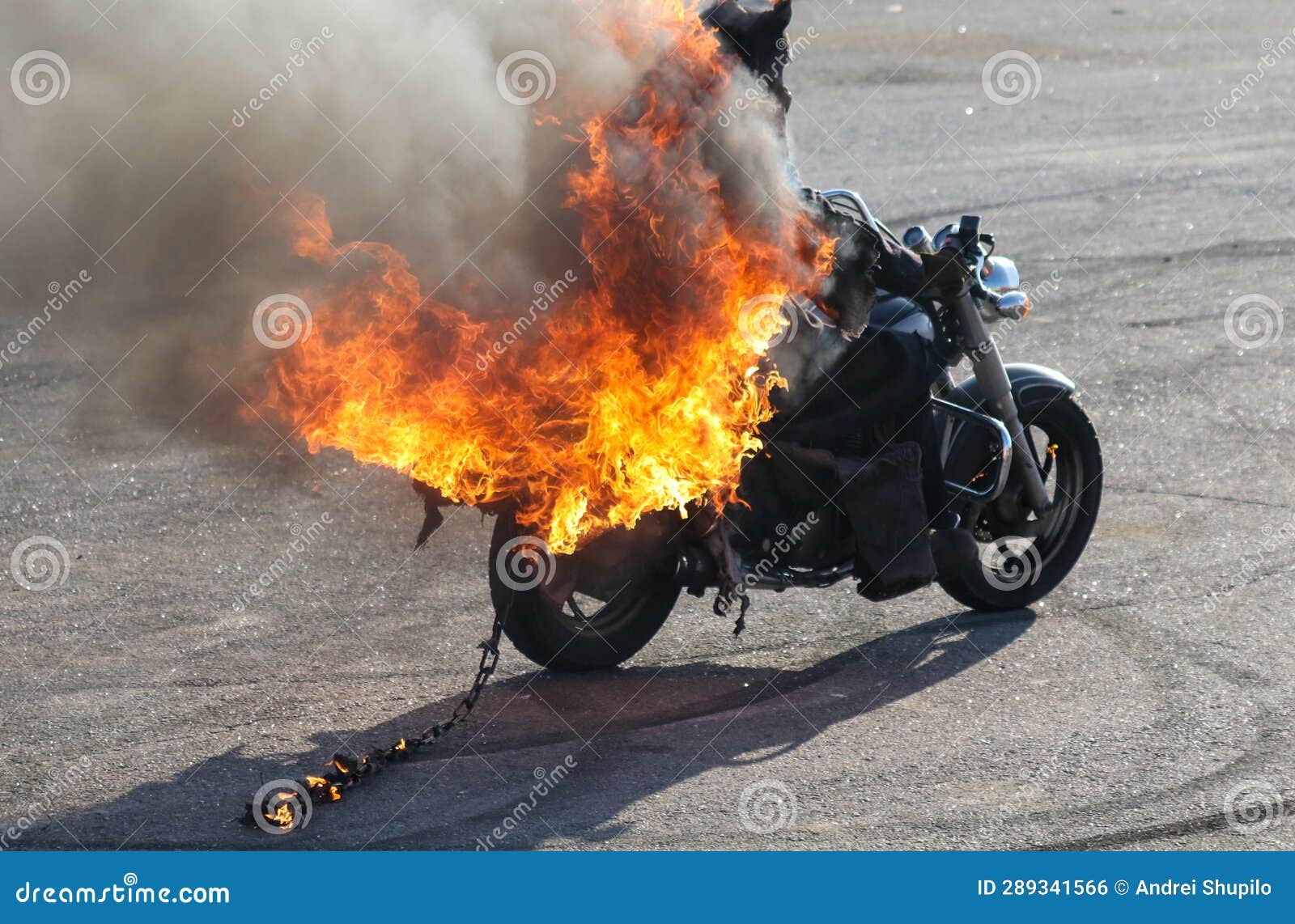The Motorcycle Rides in Flames of Fire on the Road Stock Photo - Image ...