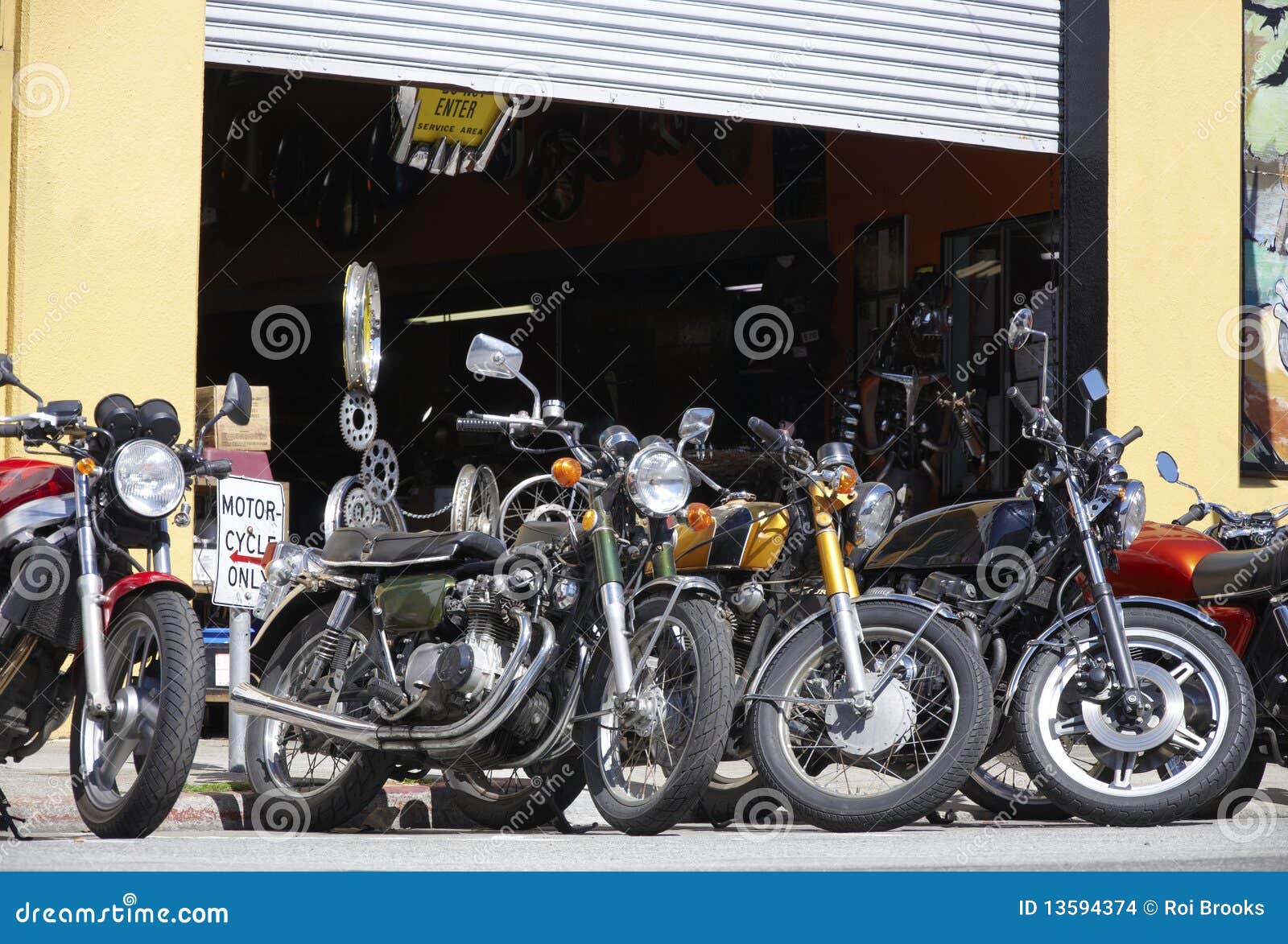 Motorcycles Outside a Workshop Stock Photo - Image of handlebars ...