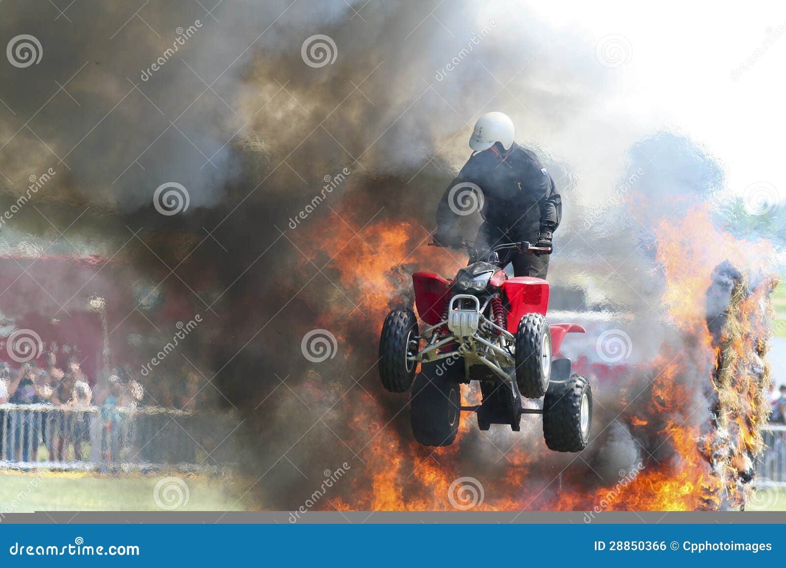 A Motorcyclist on a Quad Bike Jumping through Fire Stock Photo - Image ...