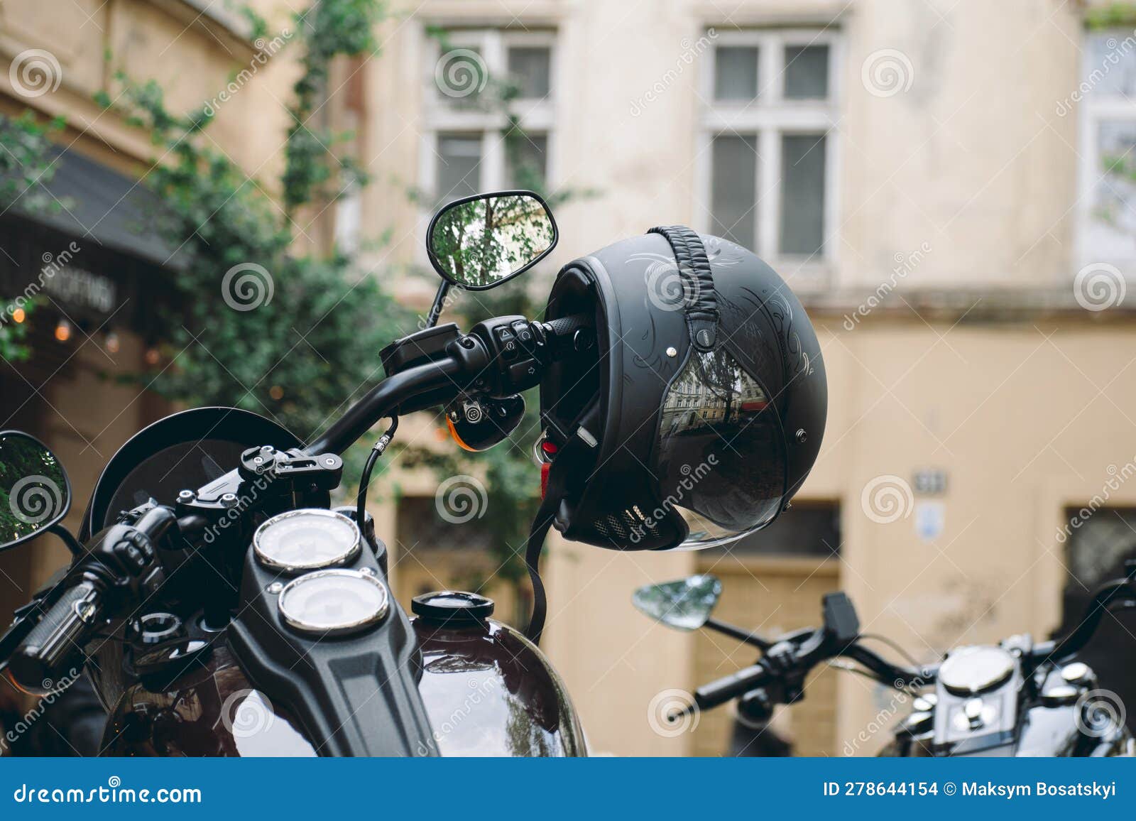 A Motorcyclist S Helmet Hangs on the Handlebars of a Motorcycle Stock ...