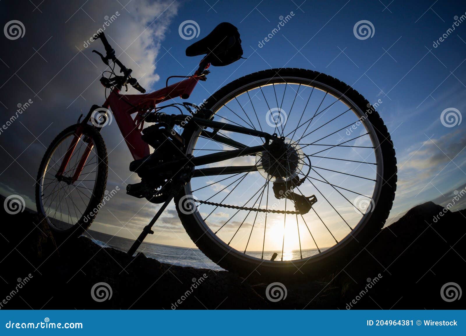 Mountain bike at sunset stock image. Image of silhouette - 204964381