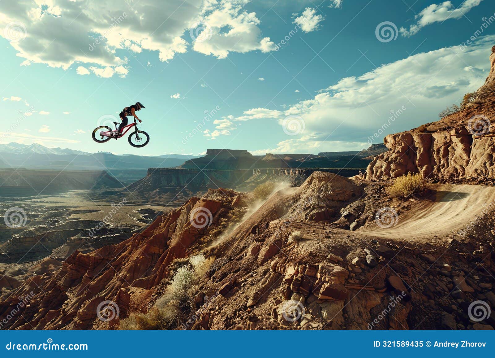 A Mountain Biker Performs a Daring Jump Over a Cliff Edge in Utah, with ...