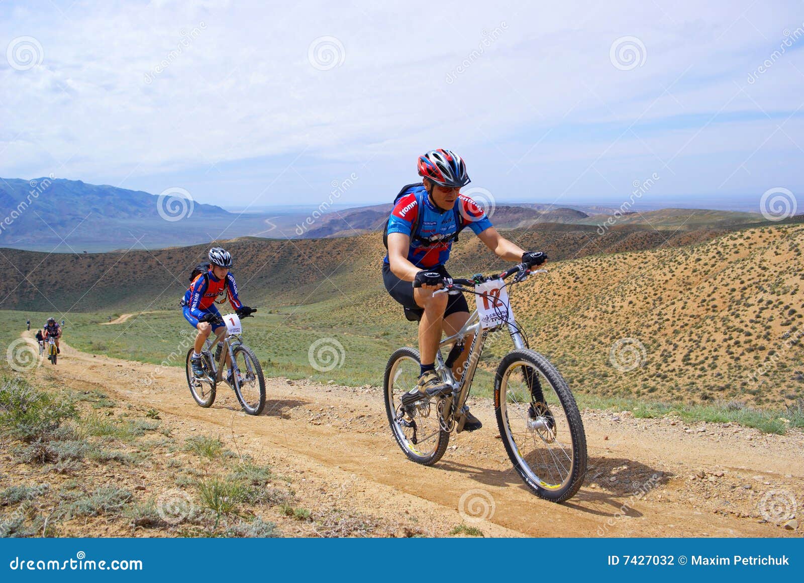 Mountain Bikers Racing on Rural Road in Desert Editorial Photography ...