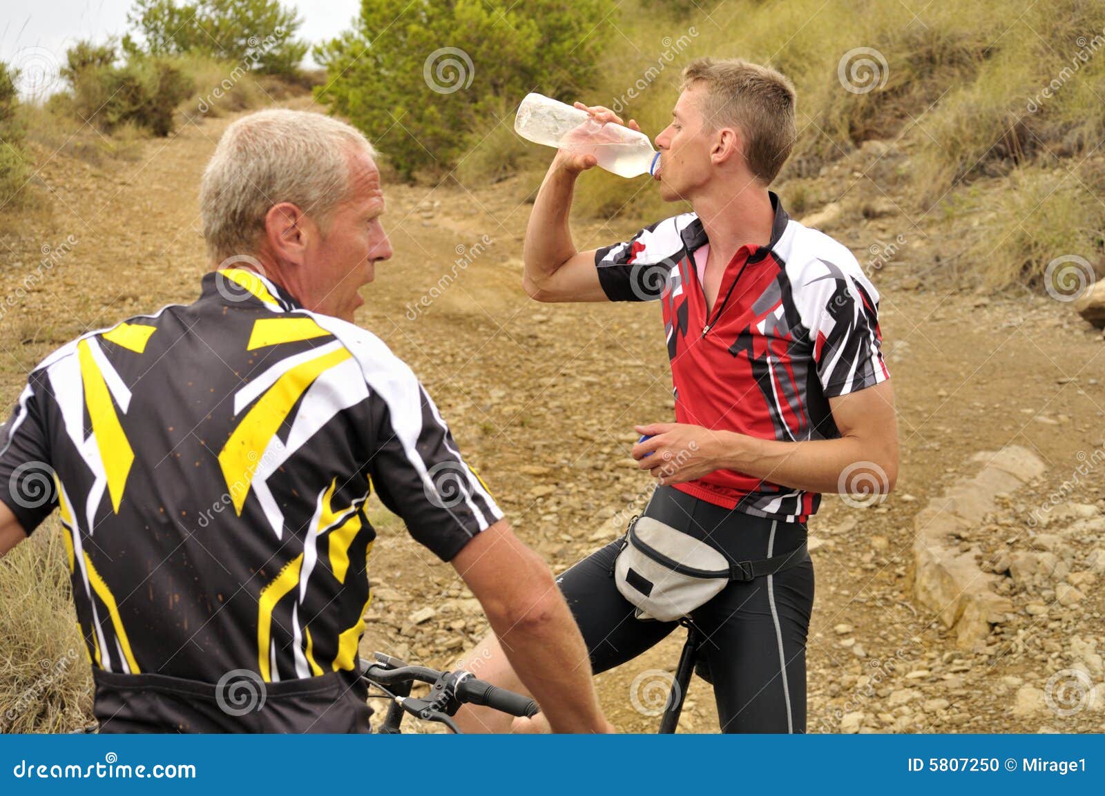 Mountain Bikers Taking a Break Stock Photo - Image of road, water: 5807250