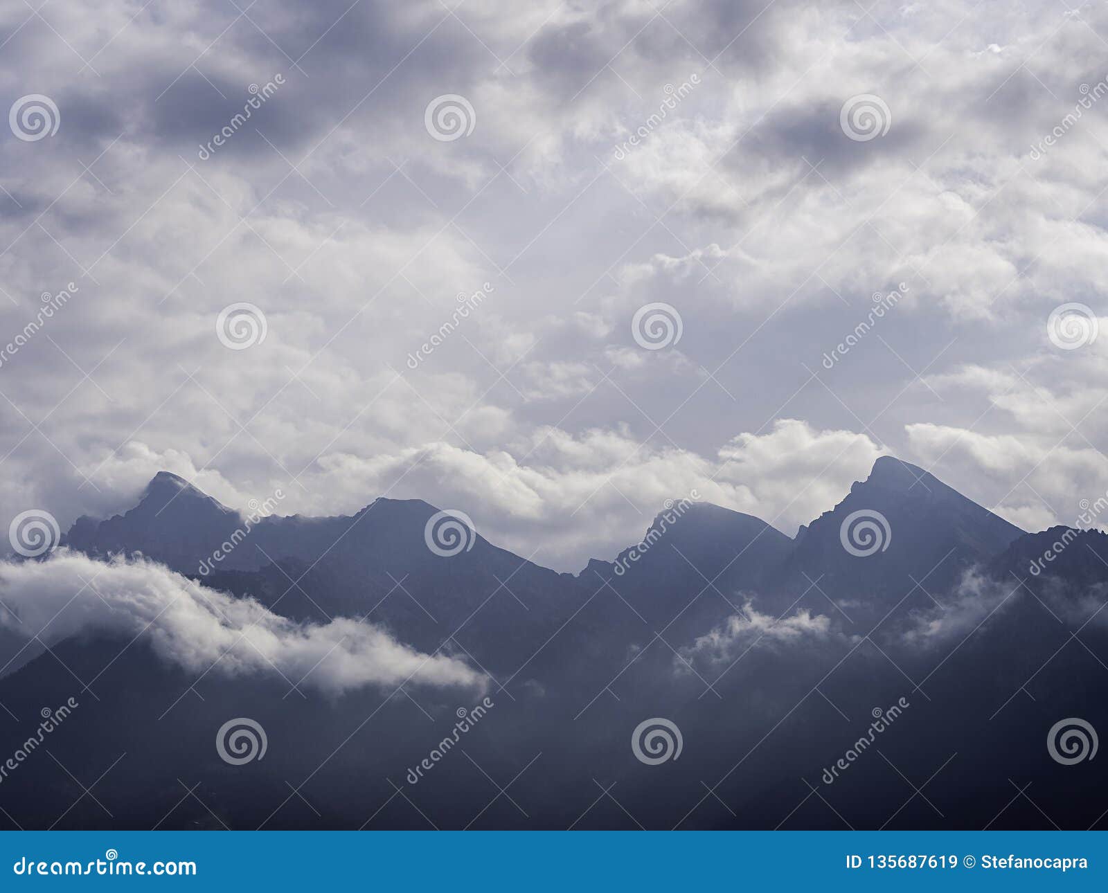 Mountain Chain Surrounded by Clouds Stock Image - Image of alone, range ...