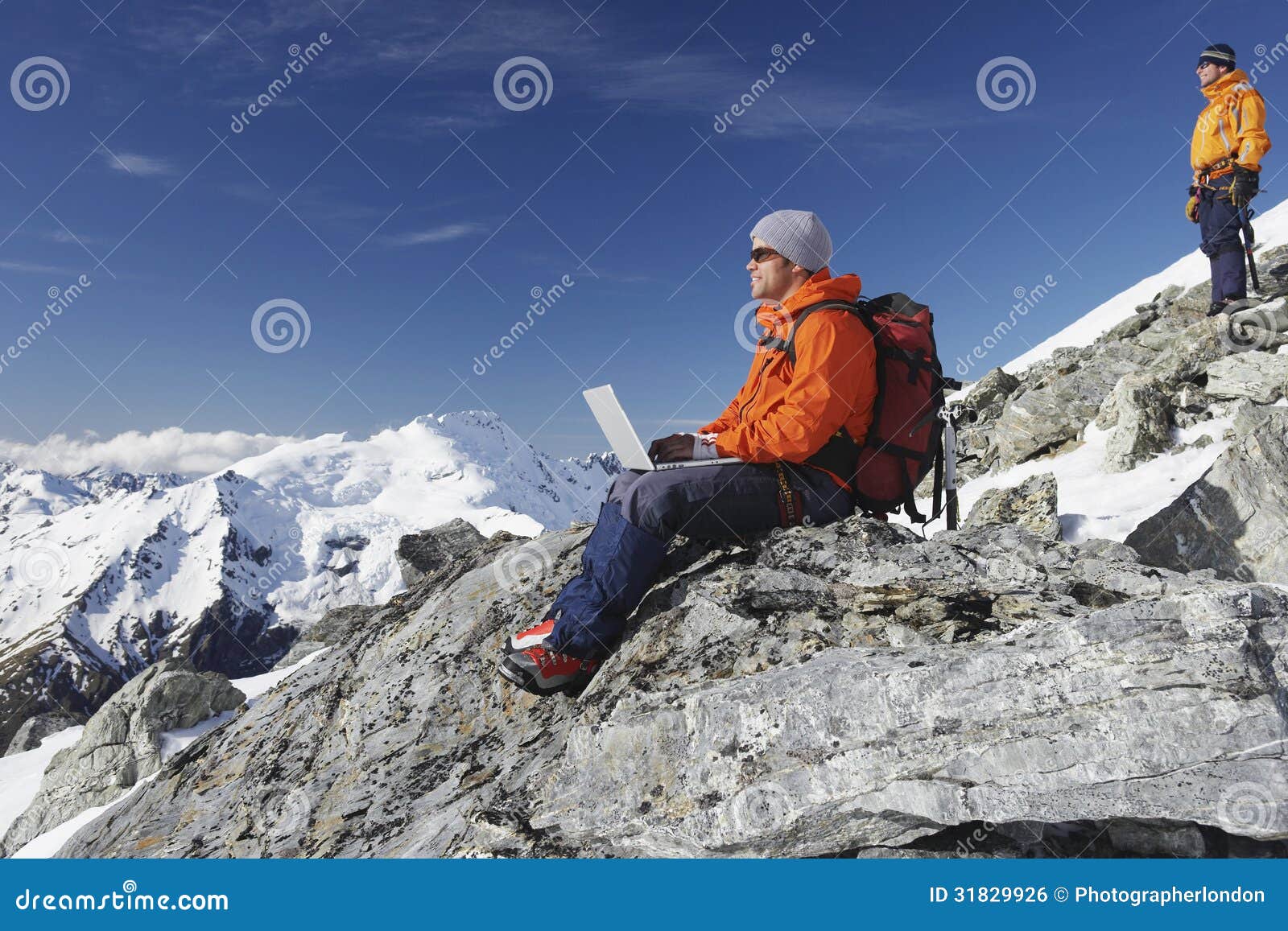 Mountain Climber Using Laptop on Mountain Peak Stock Photo - Image of ...