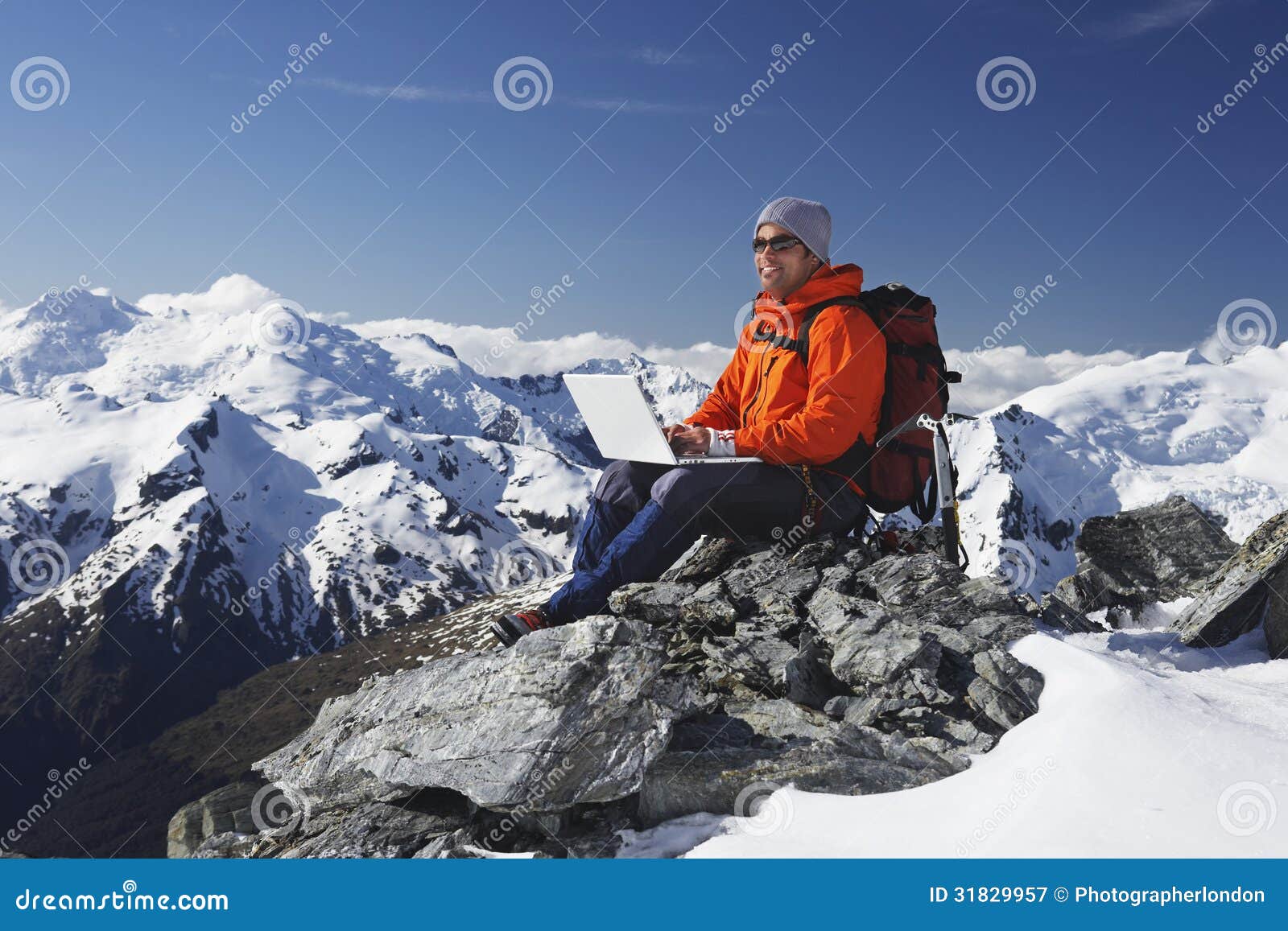 Mountain Climber Using Laptop on Mountain Peak Stock Image - Image of ...