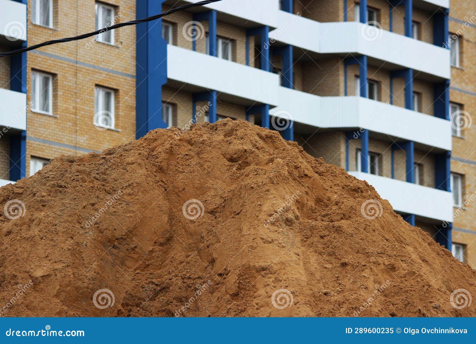 Mountain of Construction Sand in the Background of a Brick House Under ...