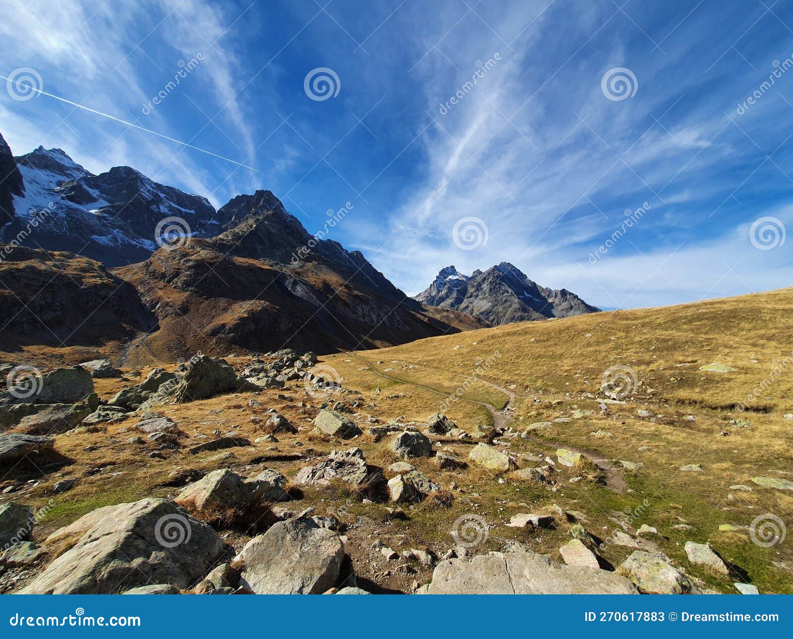 Mountain Panorama with Rocks on the First Plan and a Hiking Path with ...