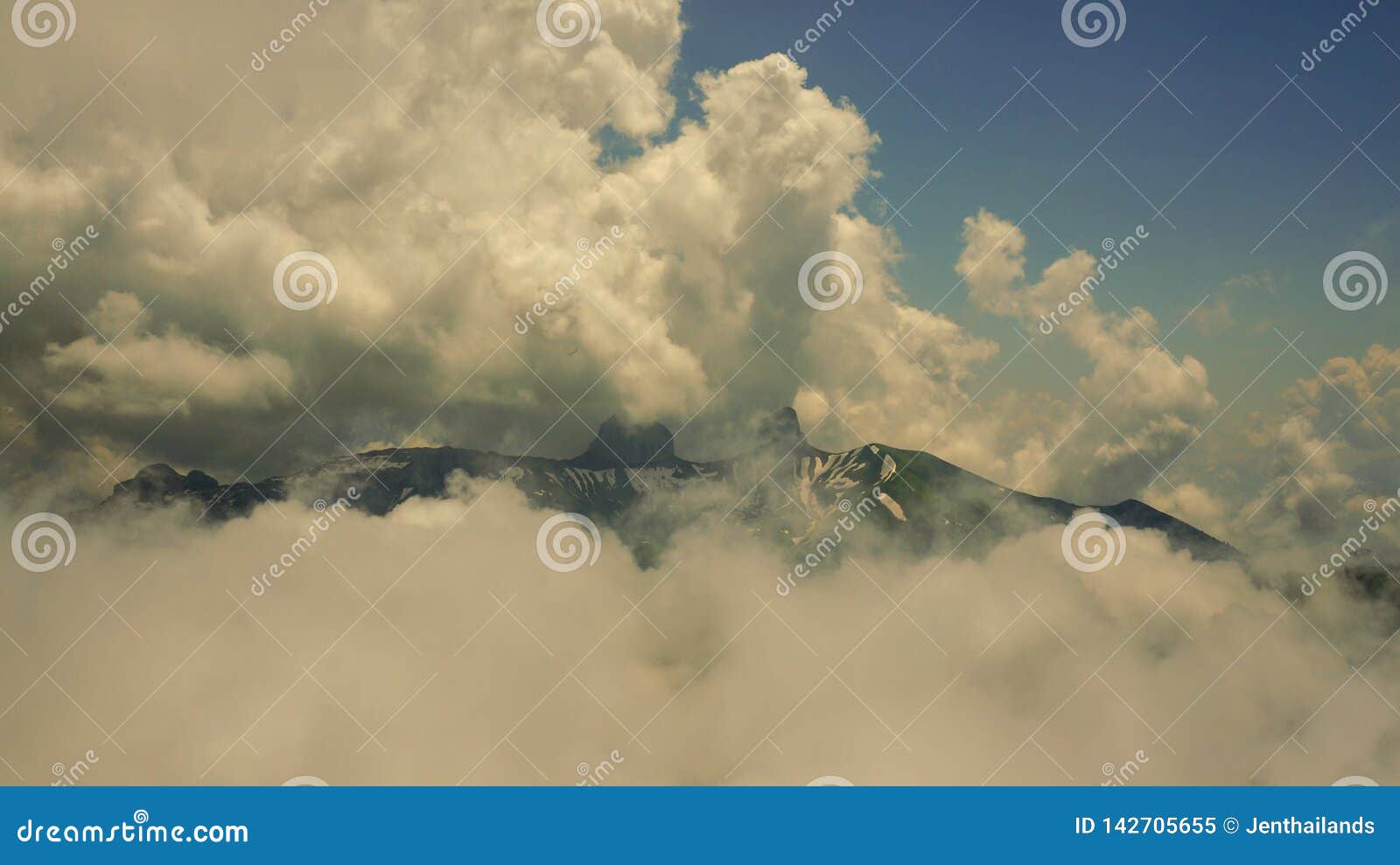A Mountain Summit Piercing through Clouds Stock Image - Image of range ...