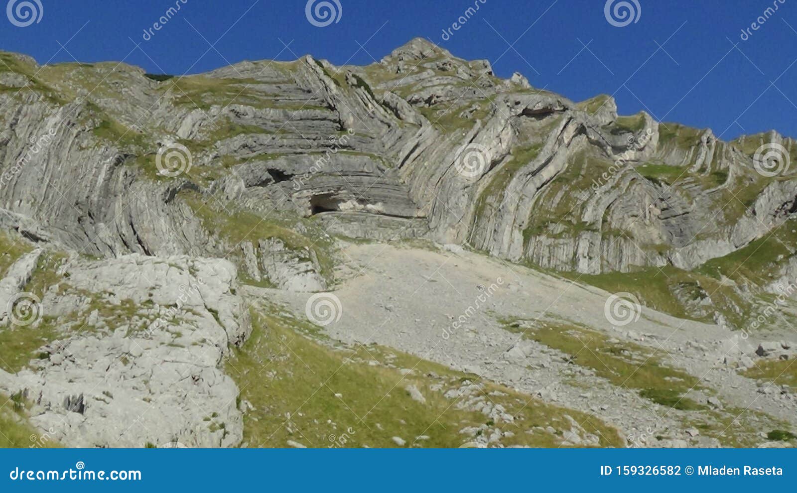 Mountain Peak with Visible Geological Layers in Struggle Stock Photo ...