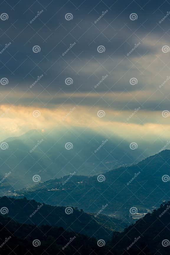 Mountain Range in the Morning with Clouds and Light Shining Down Stock ...