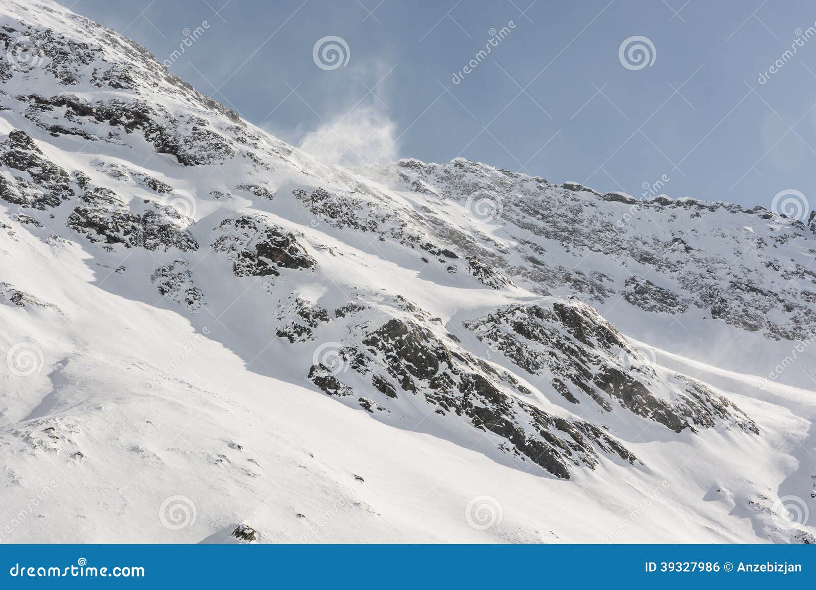 Mountain Ridge with Wind Blowing Off Some Snow Stock Photo - Image of ...