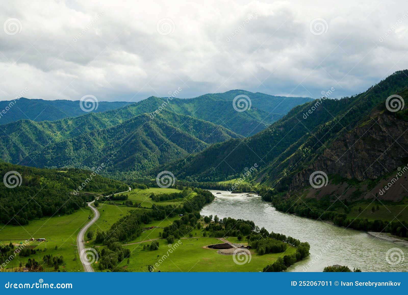 Mountain River Flows through a Green Valley between Mountains and ...