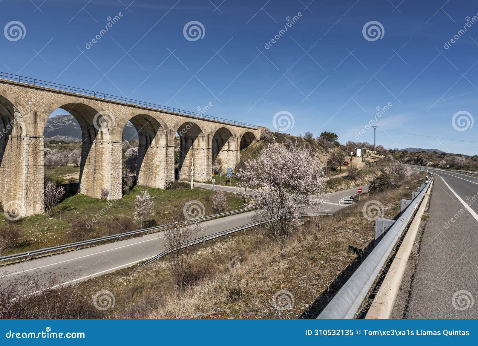 Mountain Road and a Stone Bridge Crossing a Valley with Train Tracks on ...