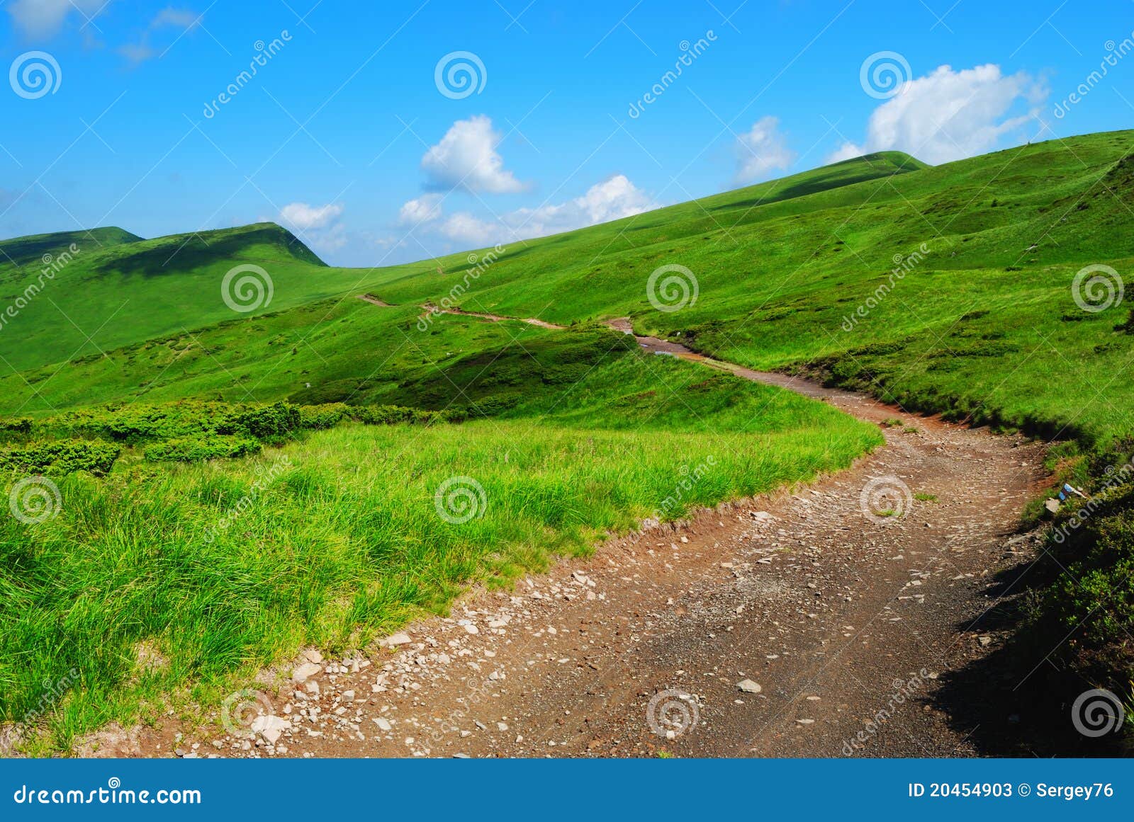 Mountain Road To Remote Green Hills Stock Image - Image of land, clouds ...