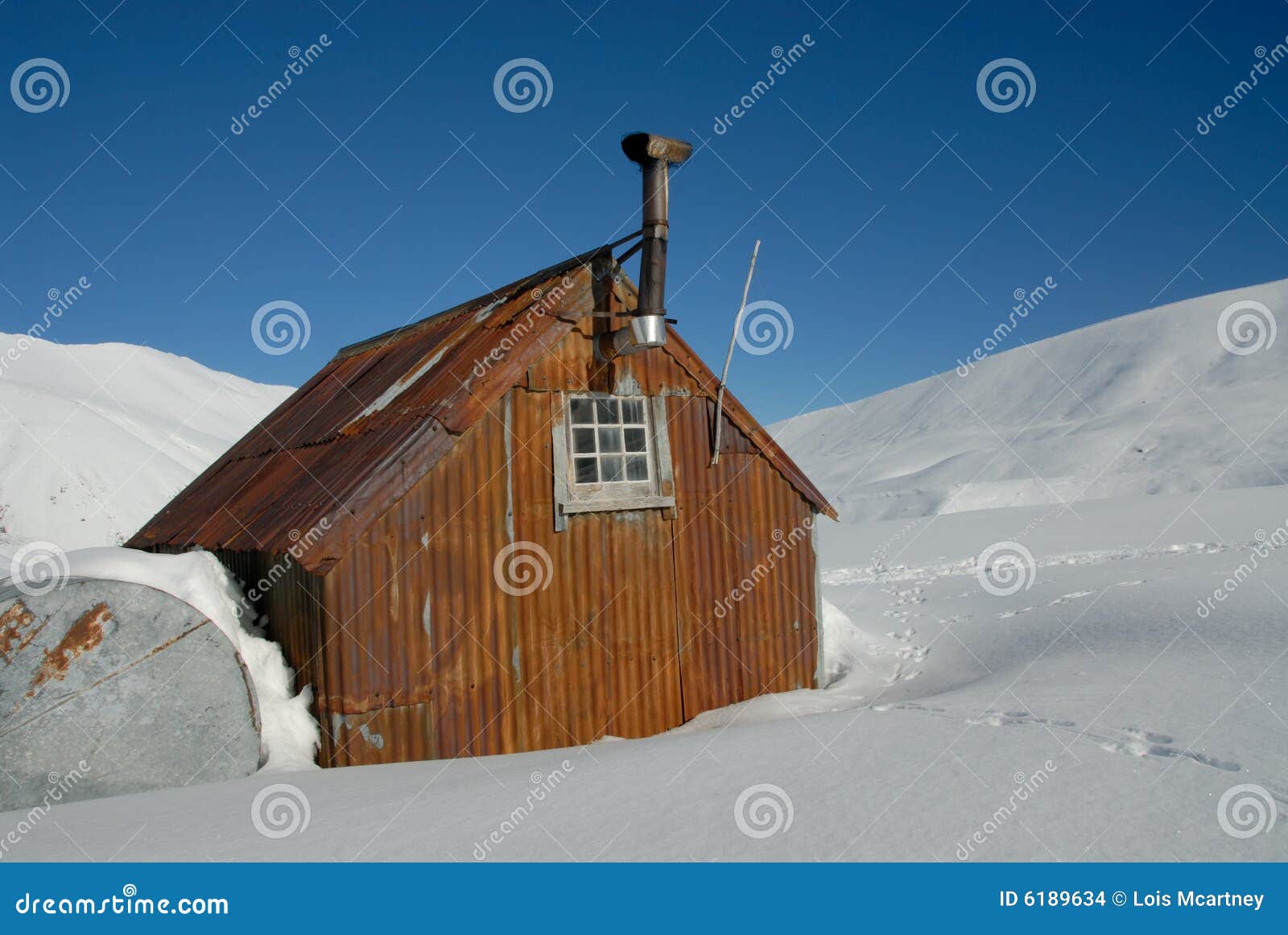 Shack In Snow Mounds With Trees And Sun Flares Stock Photography ...