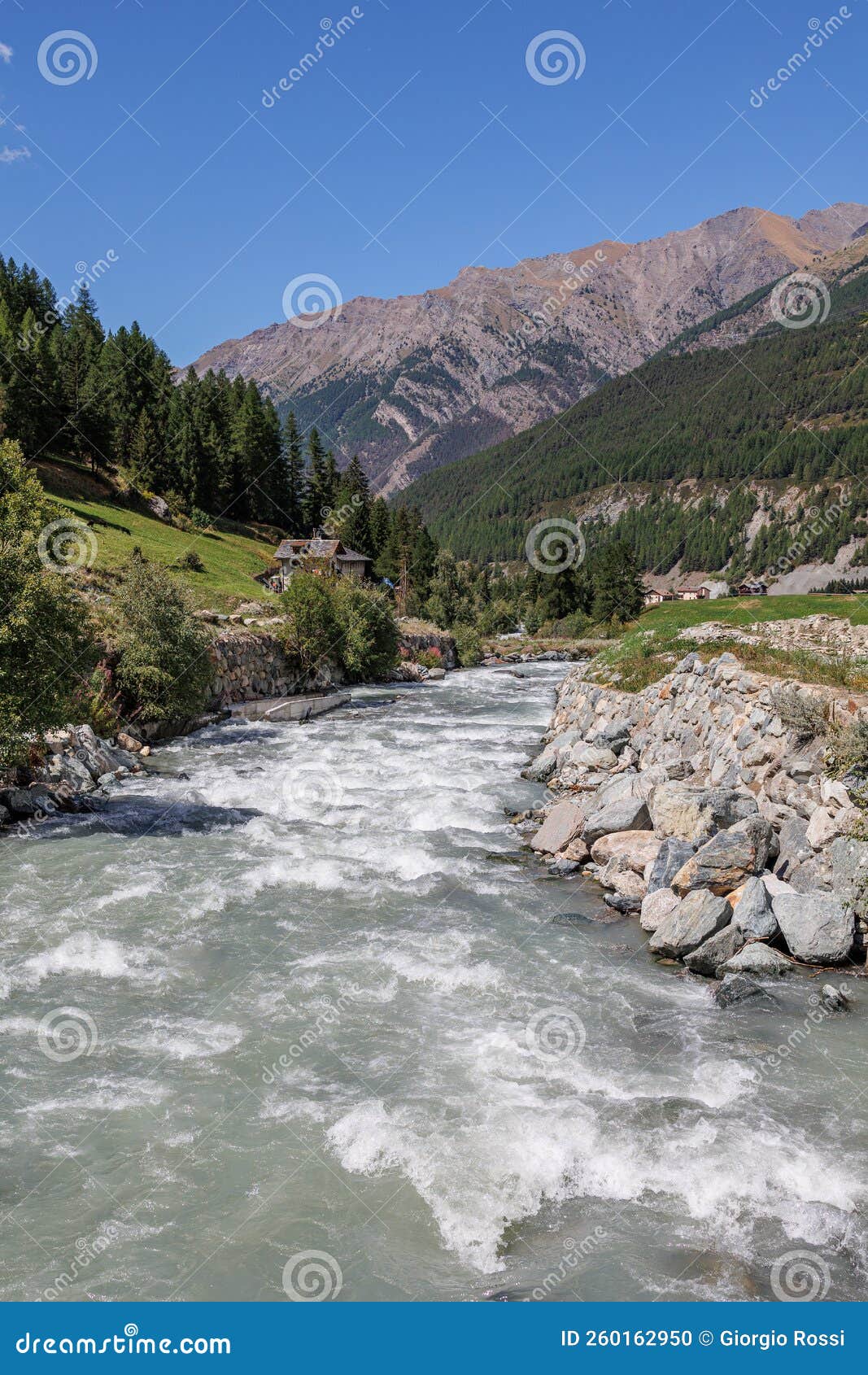 Mountain Stream and the Mountain Range of the Italian Alps on a Sunny ...