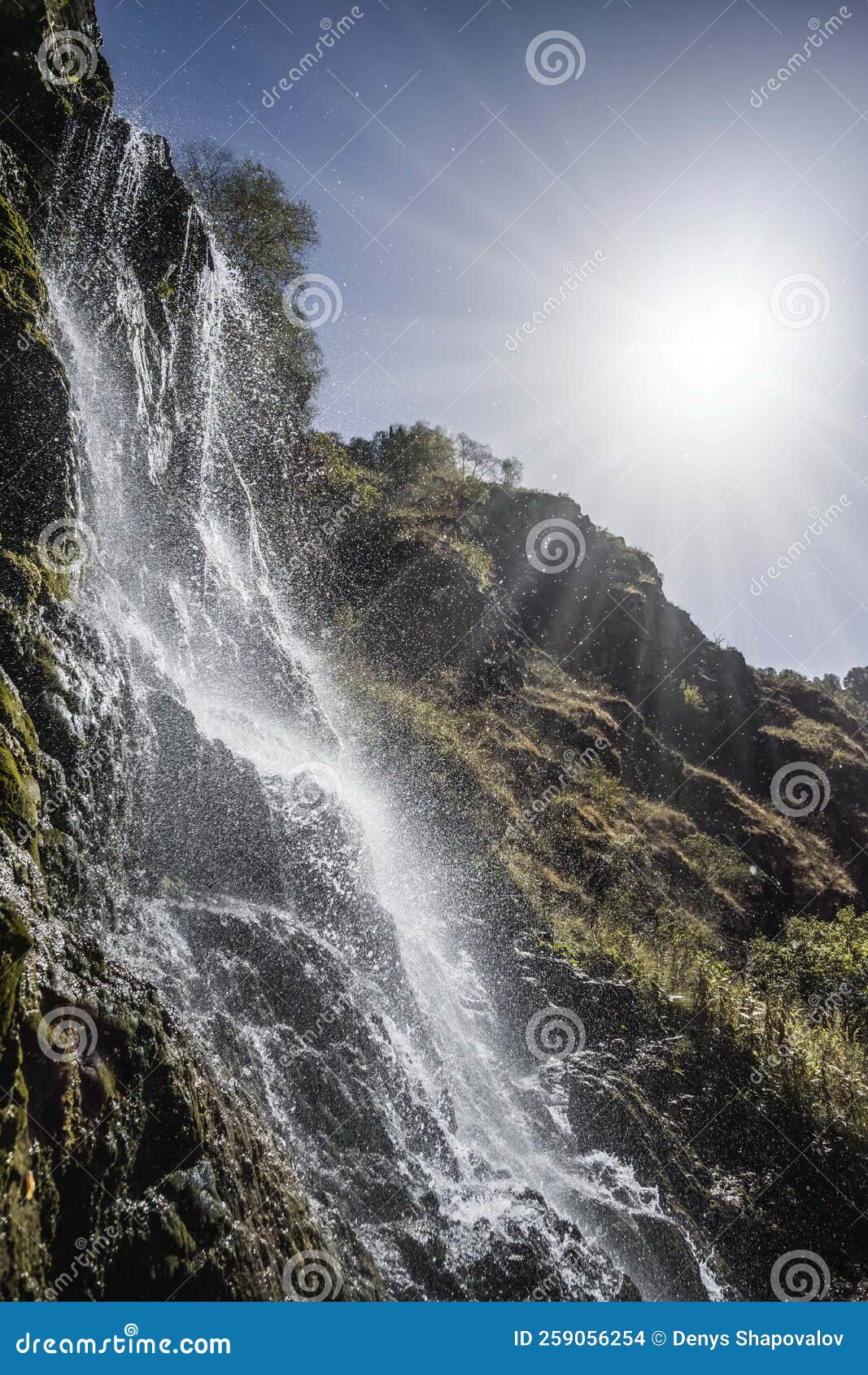 A Mountain Waterfall from a Cold River Flows Over the Rocks and ...
