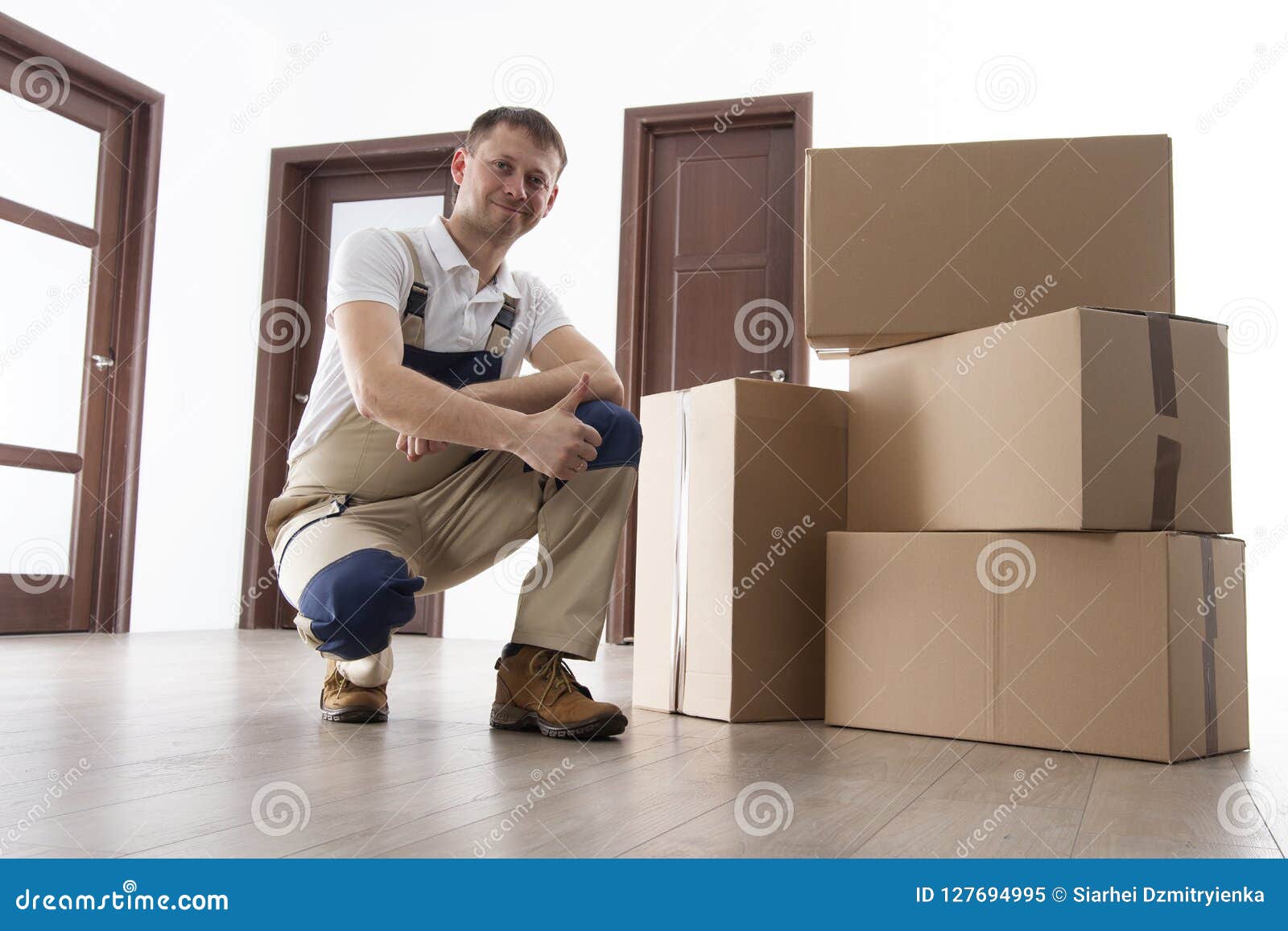 Mover with Cardboard Boxes in Apartment. Relocation Services Stock ...