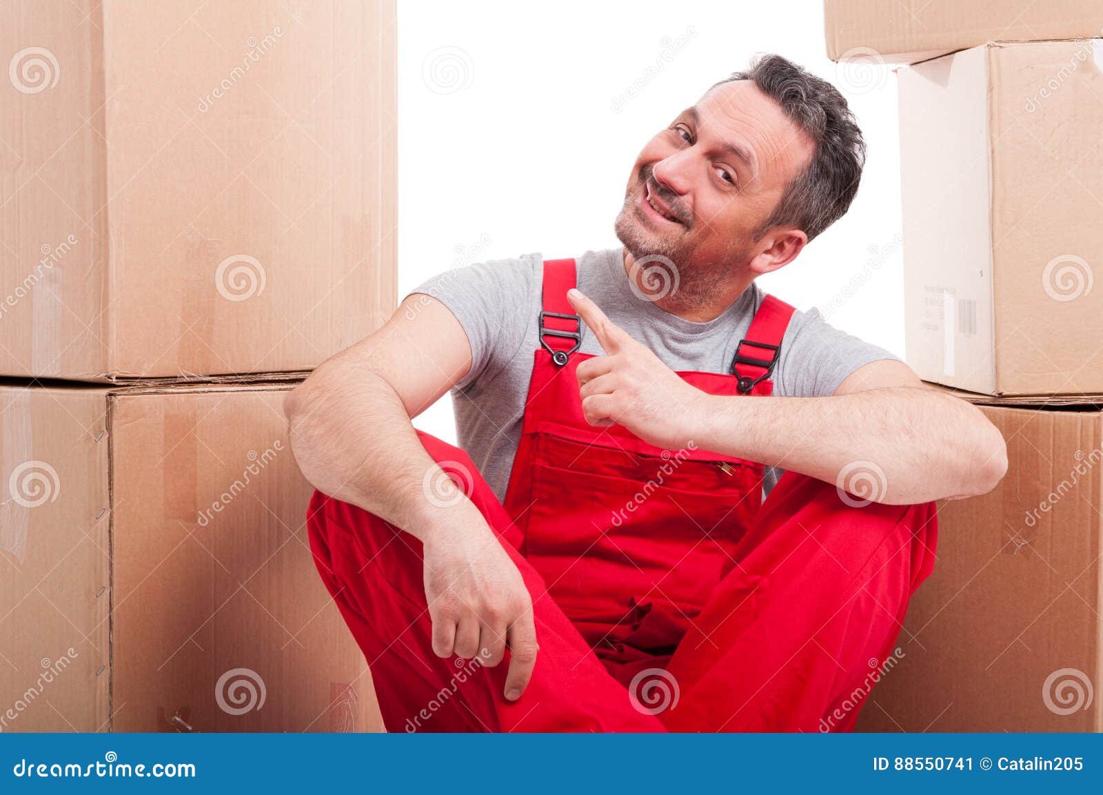 Mover Man Sitting Down and Pointing Surrounded by Boxes Stock Image ...